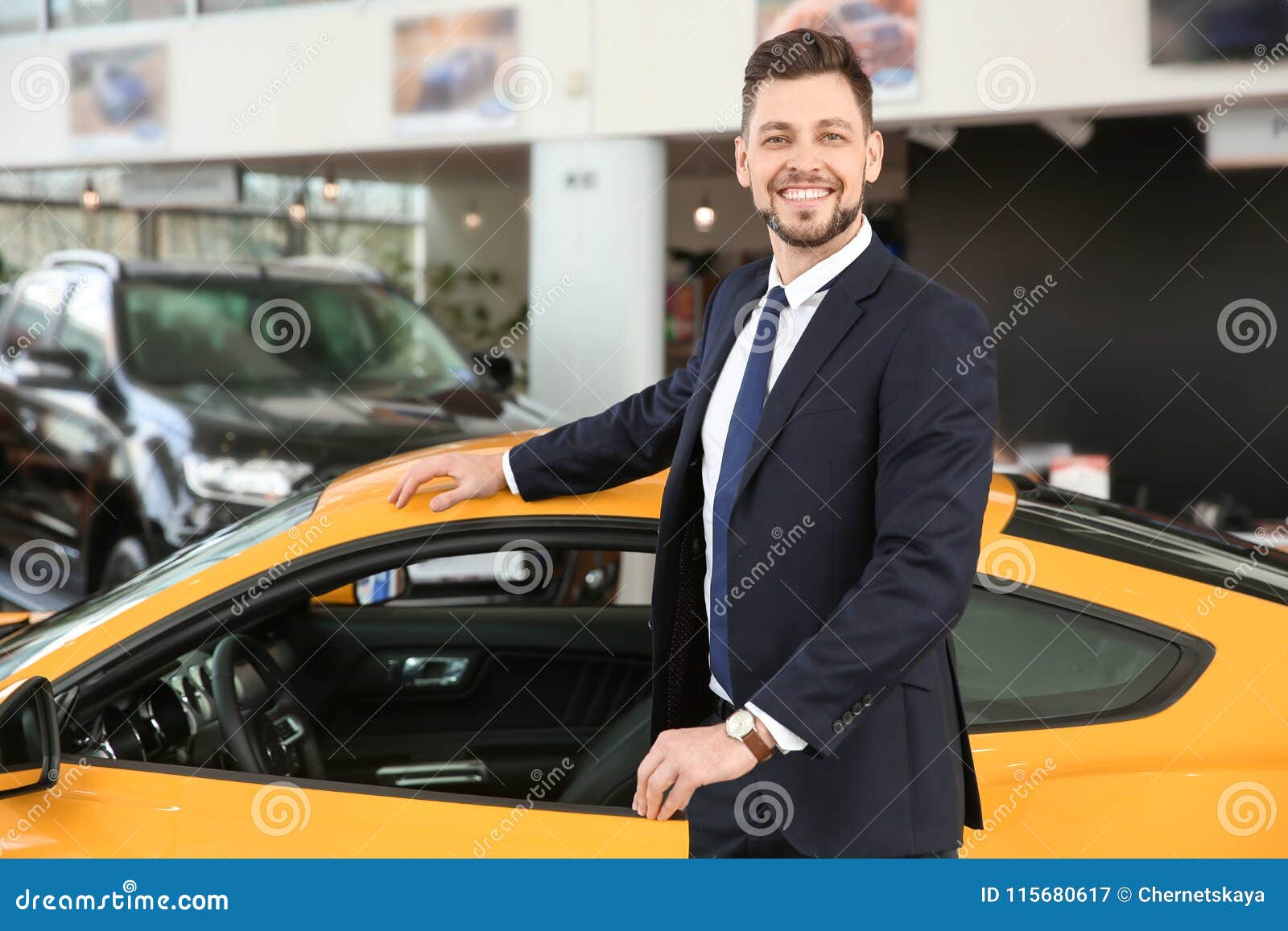 Young Businessman Standing Near Auto in Salon. Stock Image - Image of ... Young Businessman Standing Near Auto in Salon. Stock Image - Image of ...