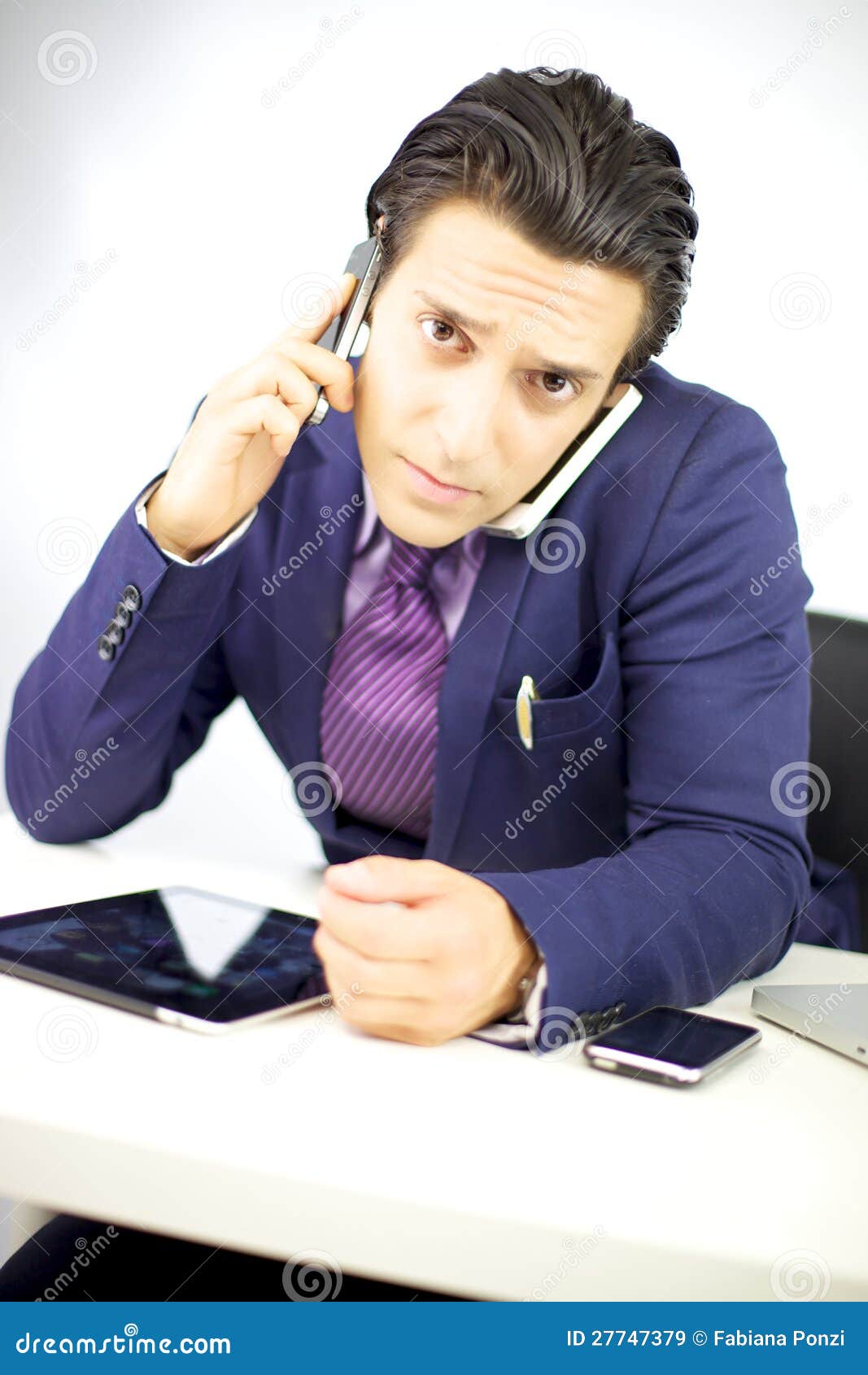 Young Businessman Talking with Two Cell Phones Stock Image - Image of internet, looking: 27747379