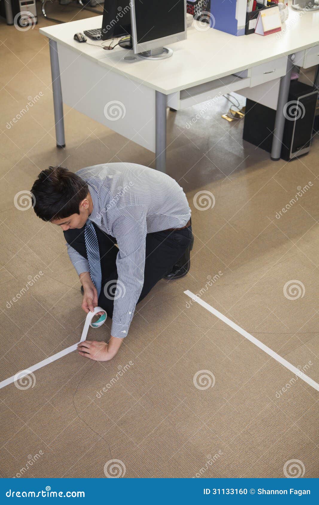 Young Businessman Taping Up the Floor in the Office Stock Photo - Image ...