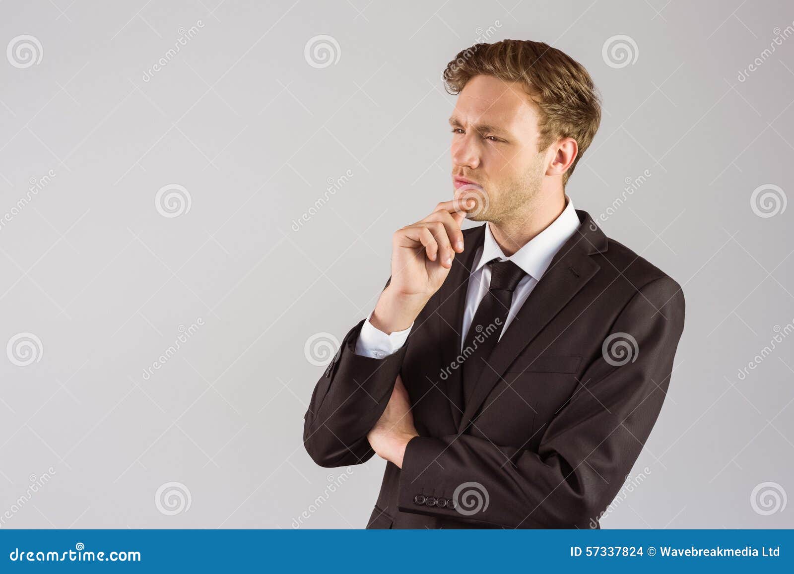 Young Businessman Thinking with Hand on Chin Stock Photo - Image of ...