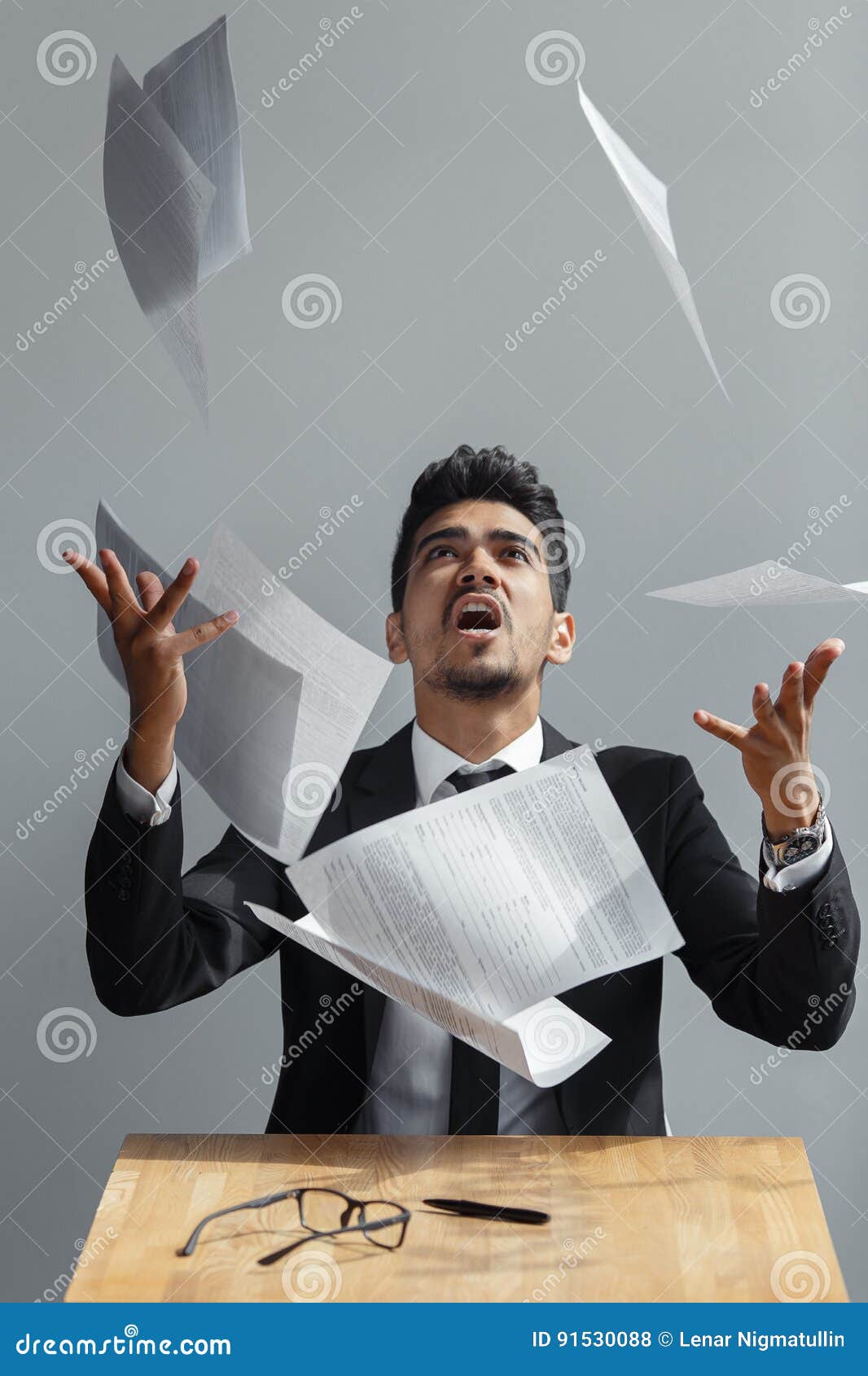 Young Businessman Throwing Some Paper Sheets on Grey Background Stock ...