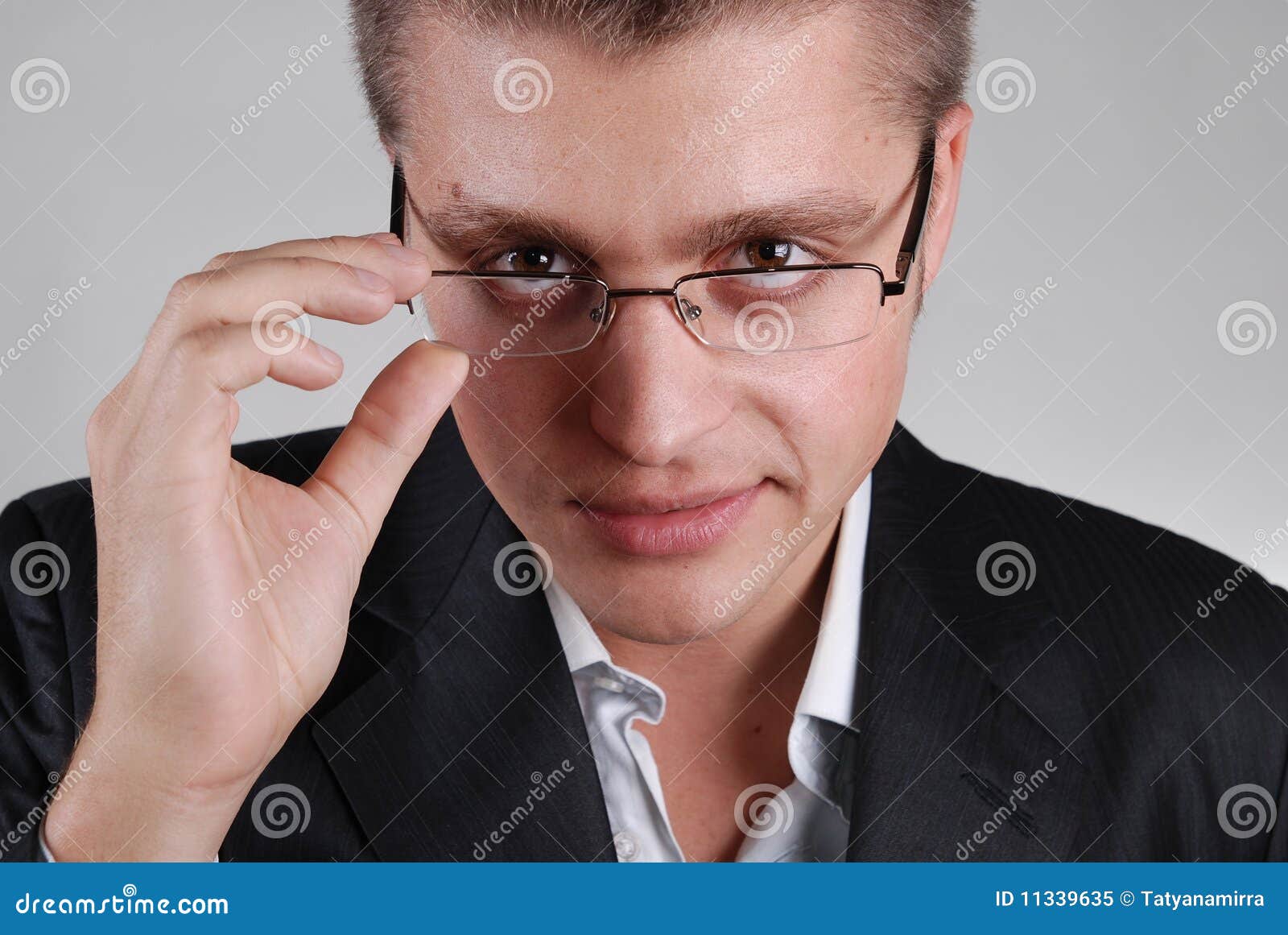 Young Businessman Touching His Glasses Stock Image - Image of youth ...