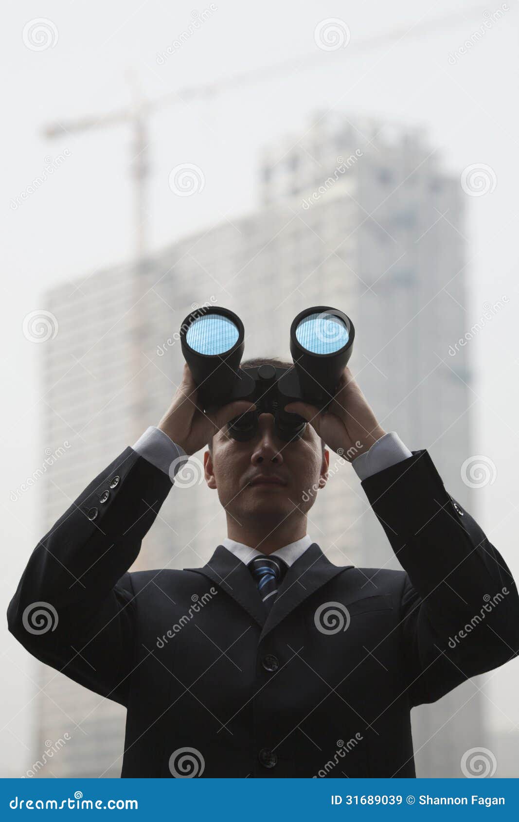 Young Businessman Using Binoculars and Looking into the Distance, Low ...