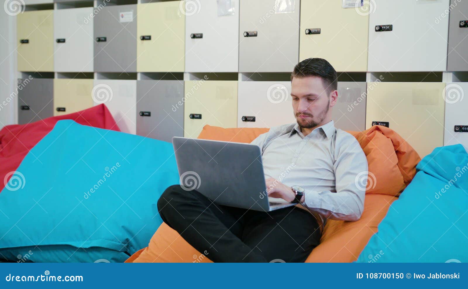 A Young Businessman Using a Laptop Indoors Stock Photo - Image of ... A Young Businessman Using a Laptop Indoors Stock Photo - Image of ...