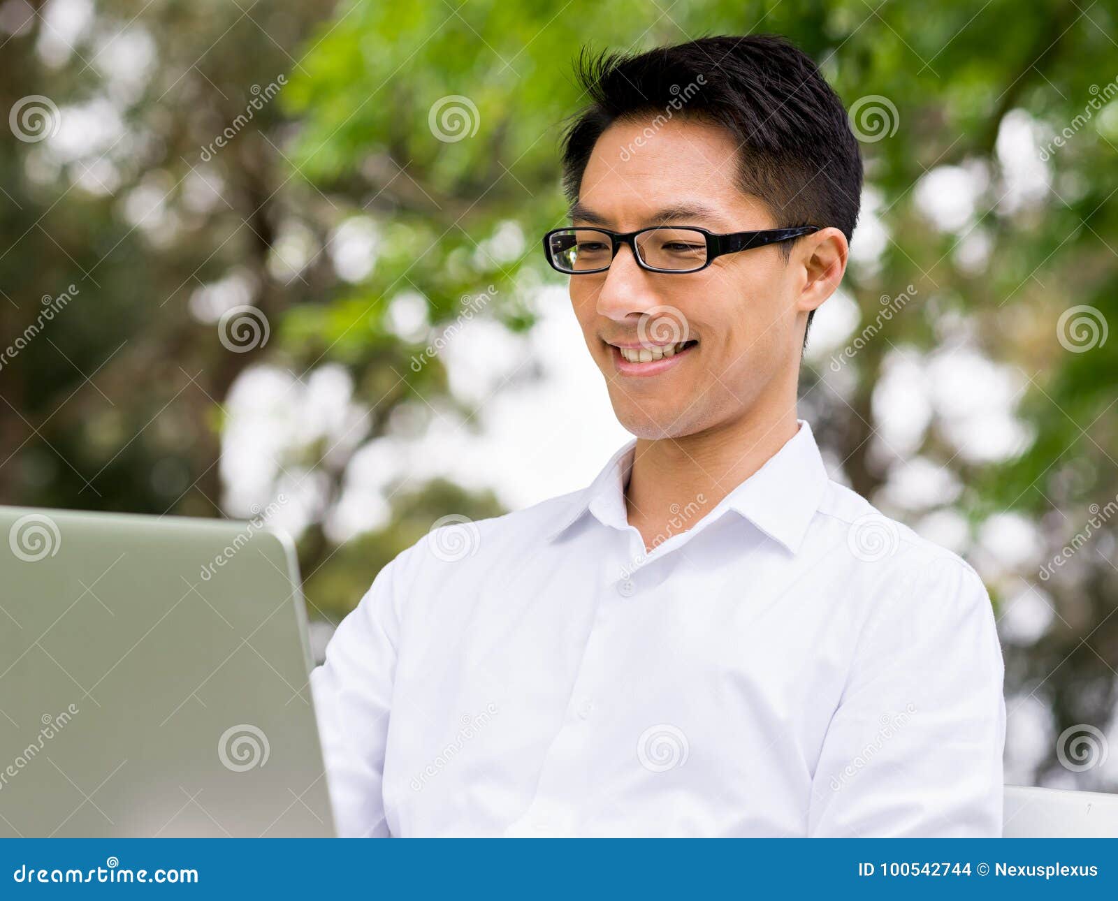 Young Businessman Using Laptop while Sitting Outdoors Stock Photo ... Young Businessman Using Laptop while Sitting Outdoors Stock Photo ...
