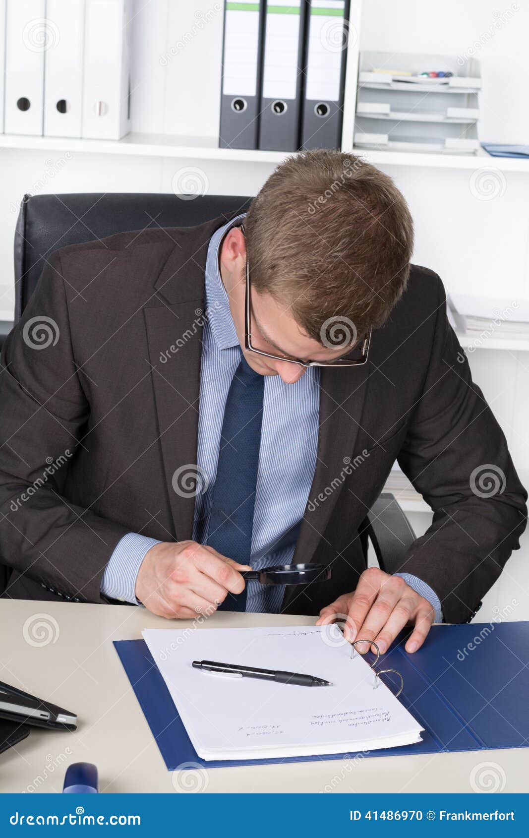 Young Businessman is Using a Magnifier Stock Photo - Image of ...