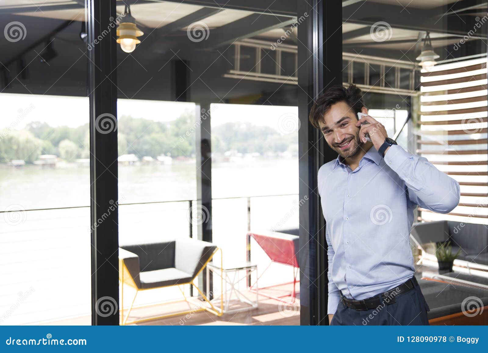 Young Businessman Using Mobile Phone in the Office Stock Photo - Image ... Young Businessman Using Mobile Phone in the Office Stock Photo - Image ...