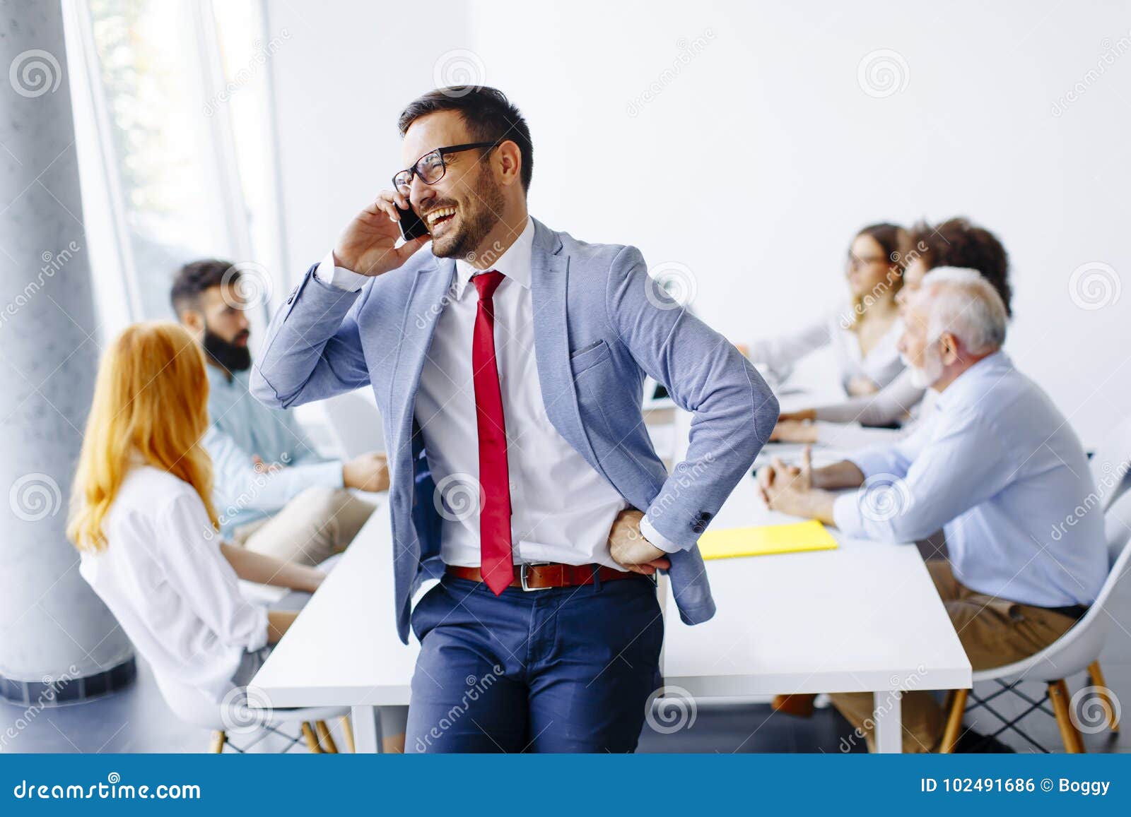 Young Businessman Using Mobile Phone in Office Stock Photo - Image of ... Young Businessman Using Mobile Phone in Office Stock Photo - Image of ...