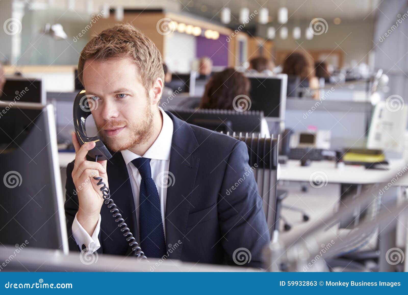 Young Businessman at Work in a Busy, Open Plan Office Stock Image ...