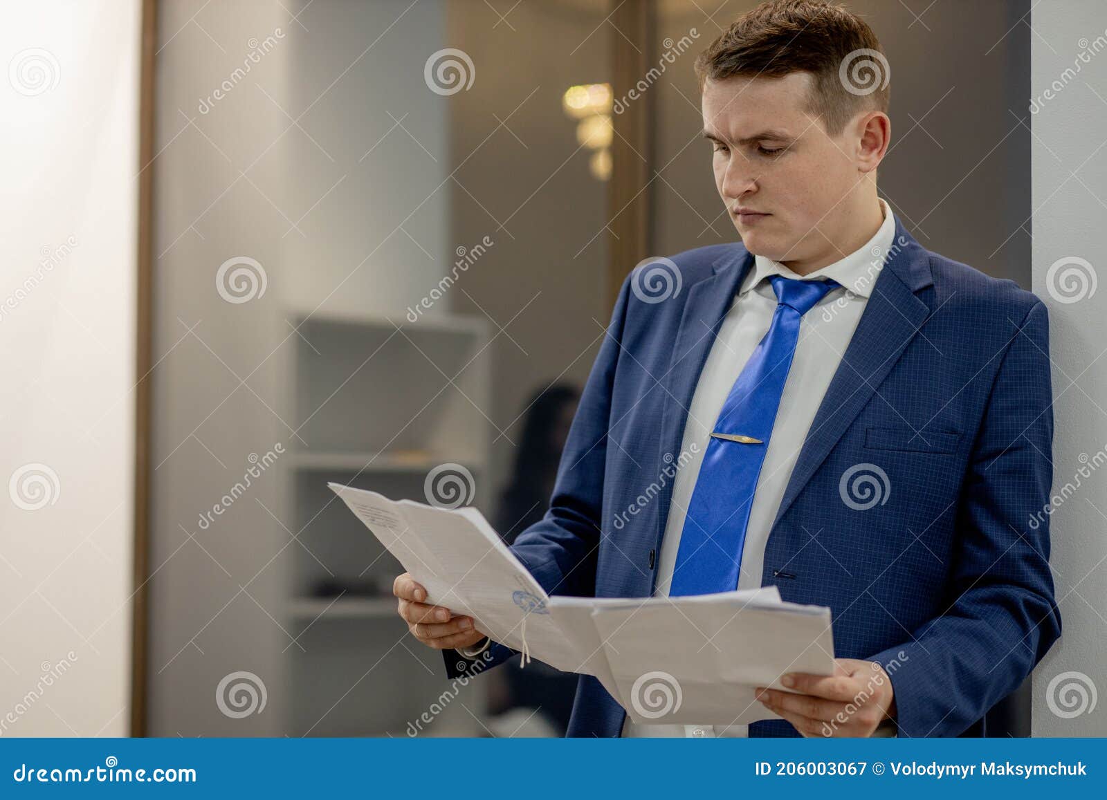 Young Businessman Working with Documents Looking through Papers in ...