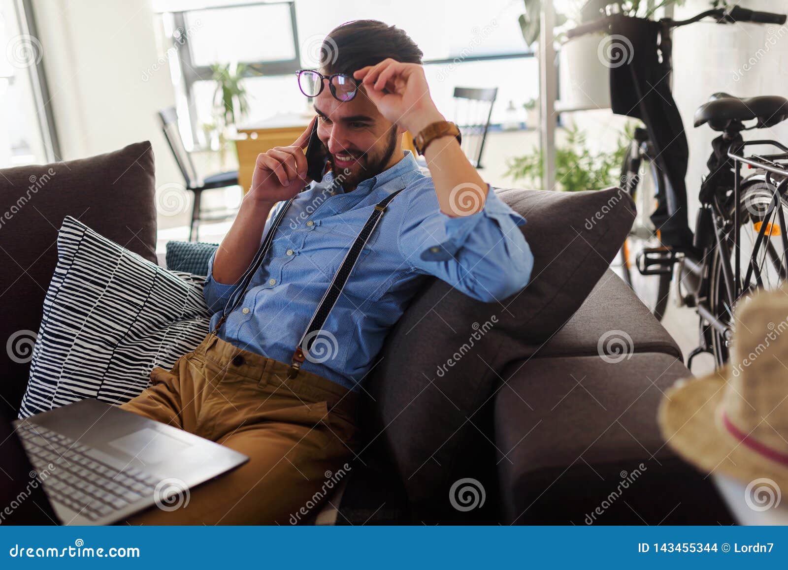 Young Businessman Working on Laptop Computer while Sitting on Sofa at ...