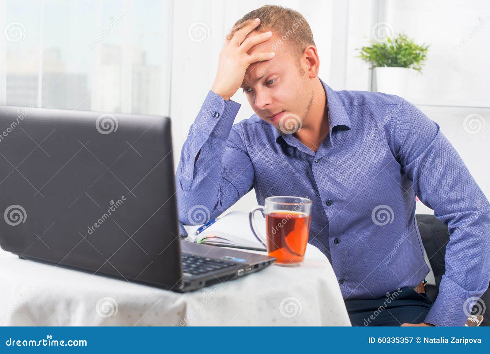 Young Businessman Working in the Office, Very Concerned, Solves Problem ...