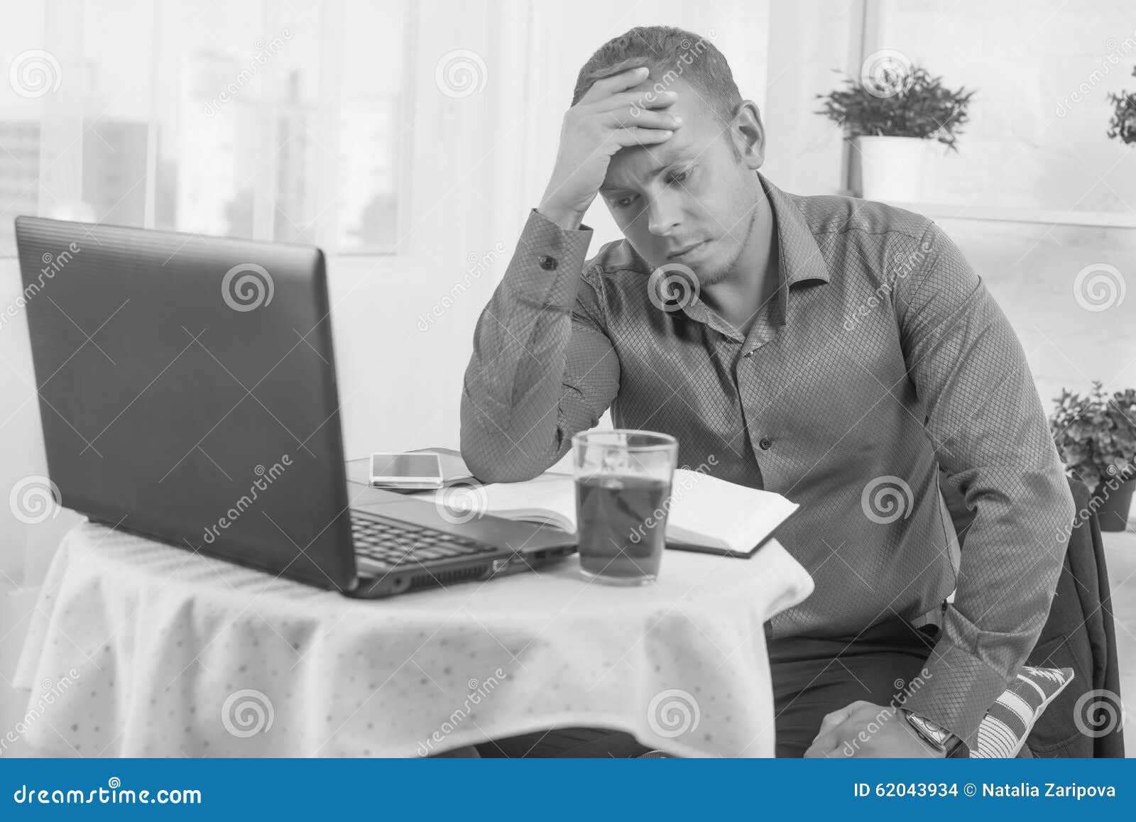 Young Businessman Working in the Office, Very Concerned, Solves Problem ...