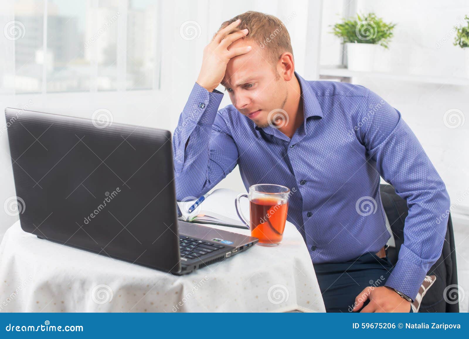 Young Businessman Working in the Office, Very Concerned, Solves the ...