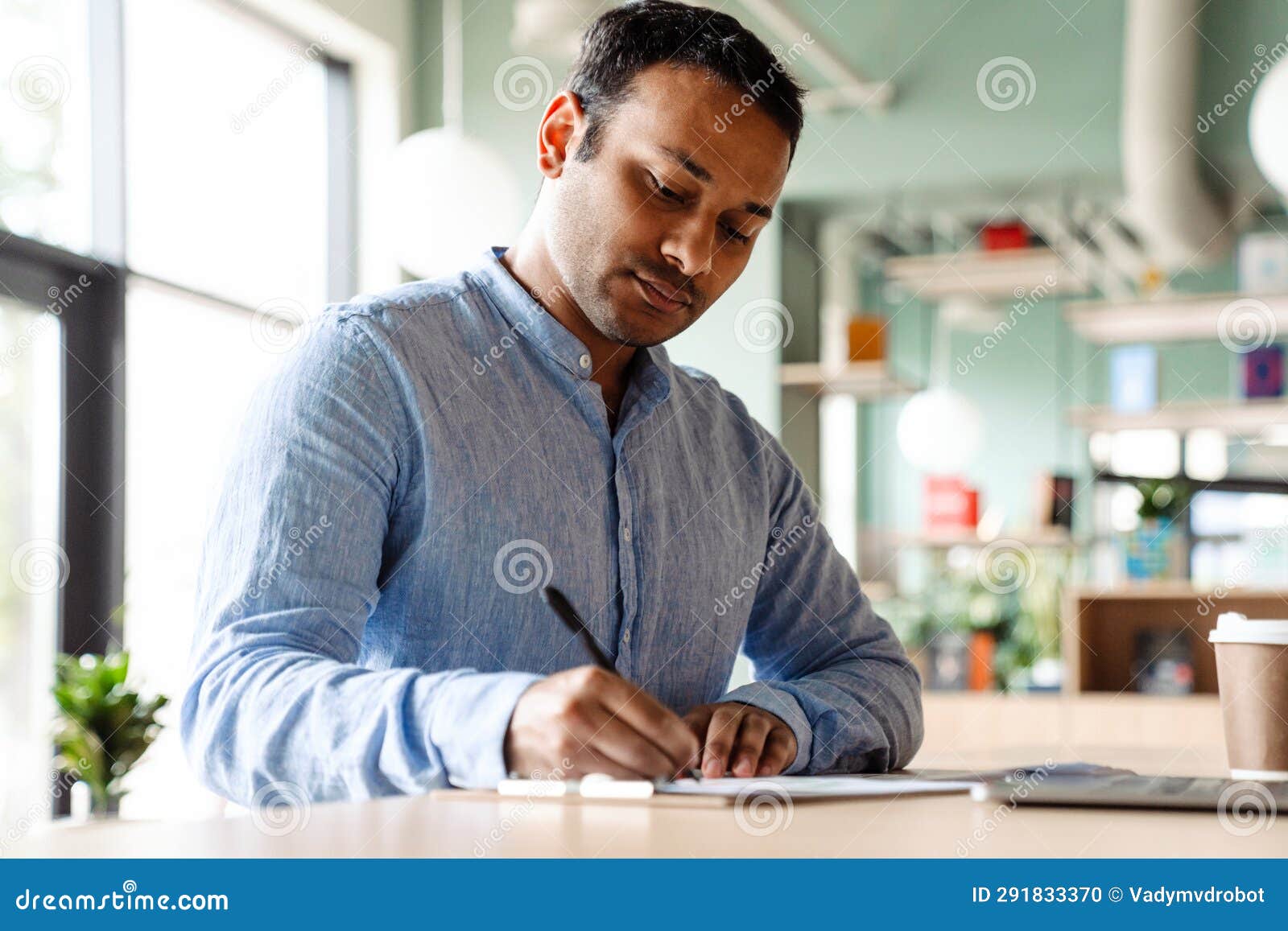 Young Businessman Writing Down Notes while Working at Office Stock ...