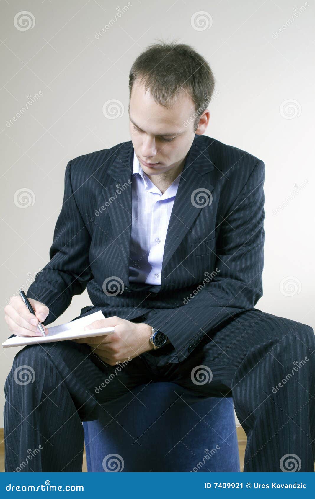 Young Businessman Writing in His Notebook Stock Image - Image of ...