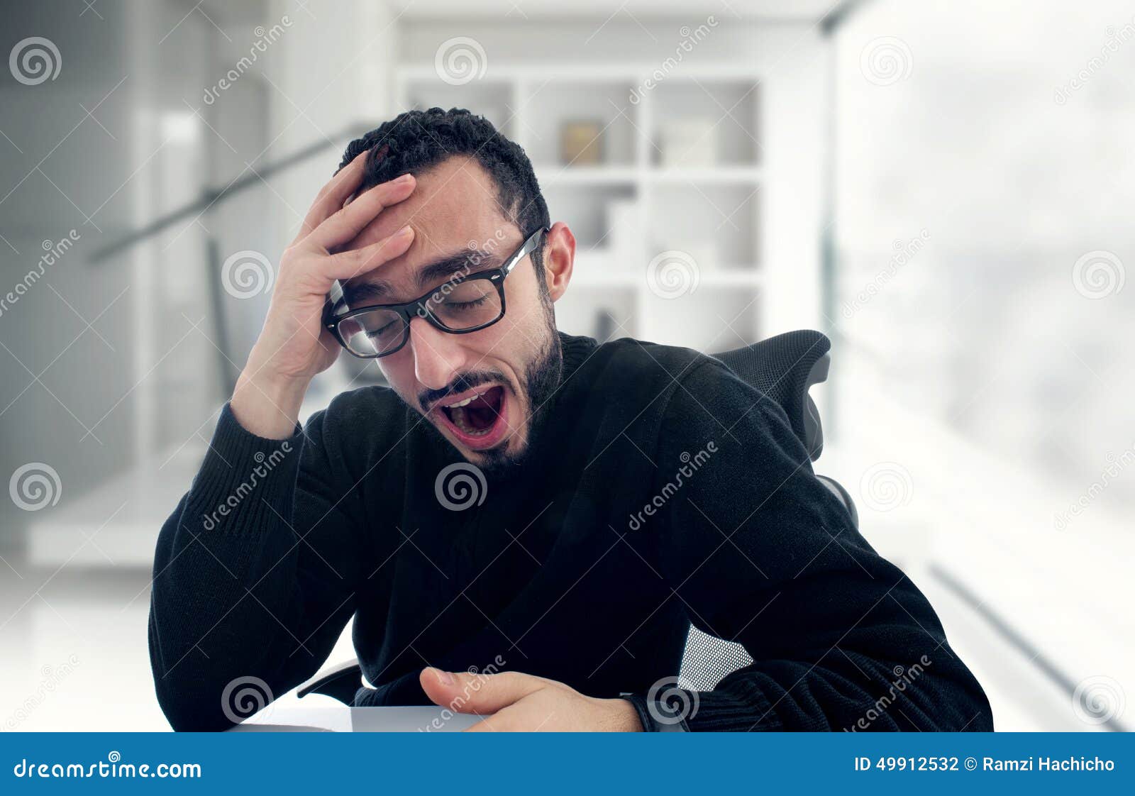 Young Businessman Yawning at Work in Office . Stock Photo - Image of ...