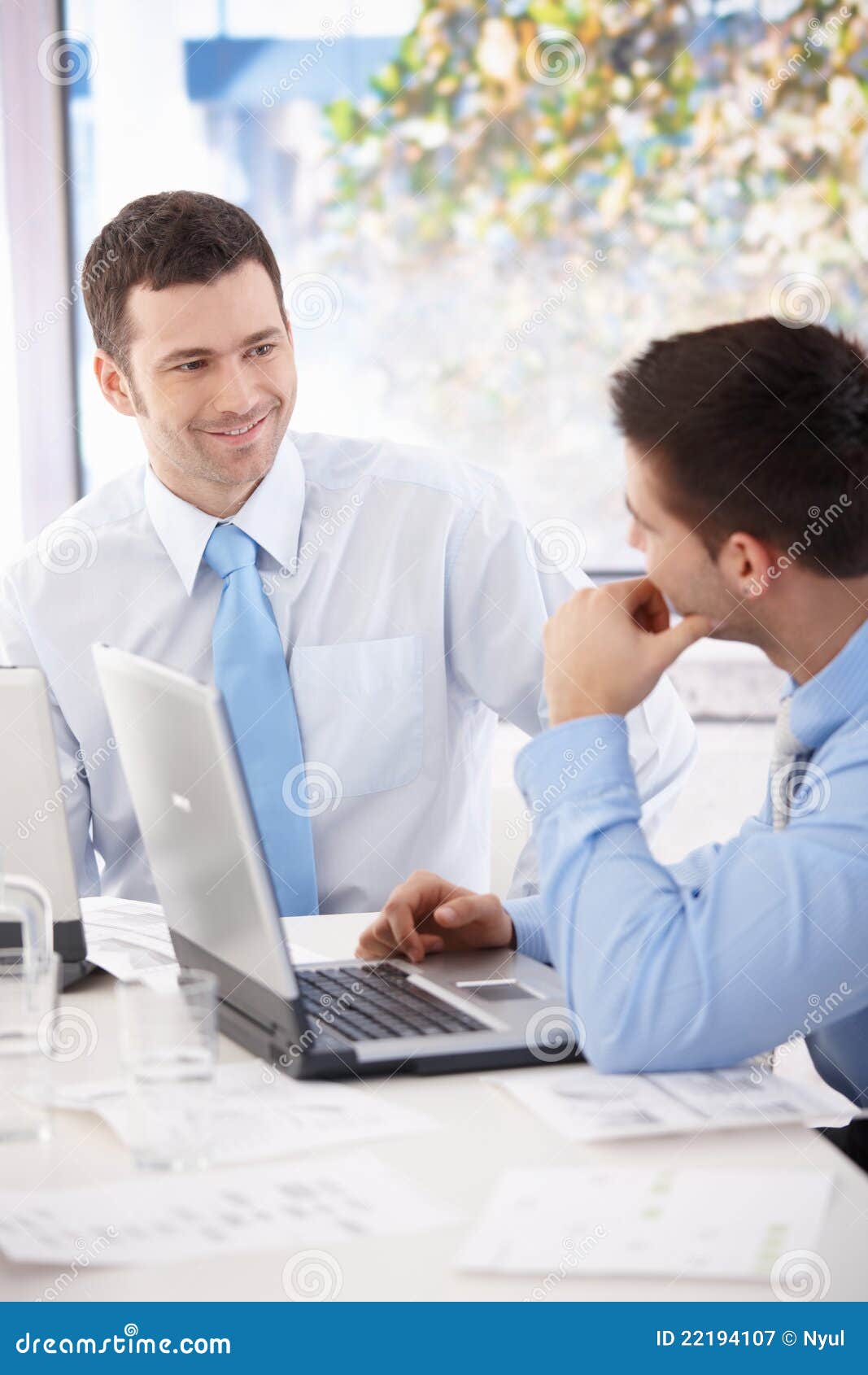 Young Businessmen Talking at Meeting Table Stock Image - Image of ...