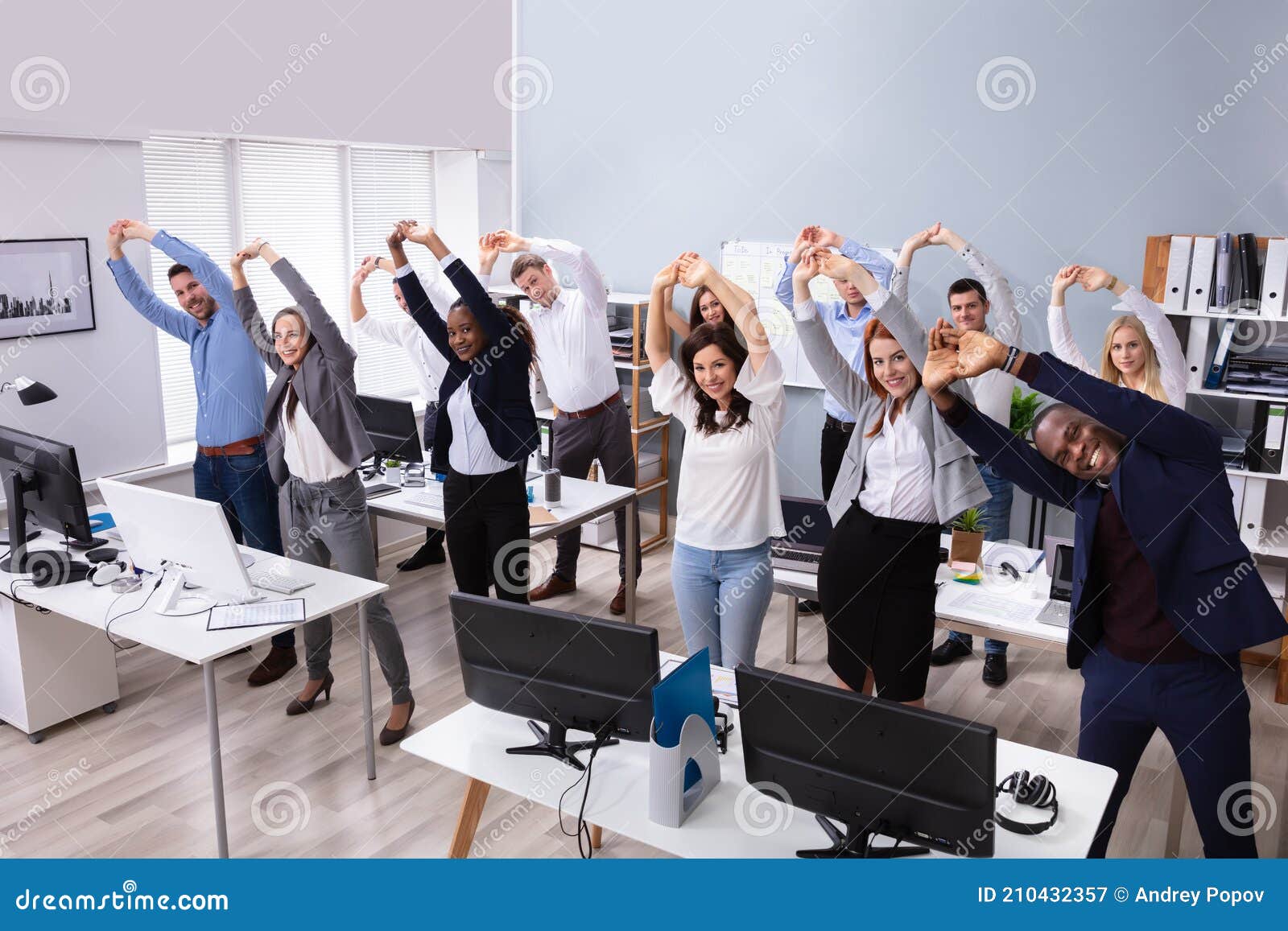 Young Businesspeople Doing Stretching Exercise at Workplace Stock Image ...