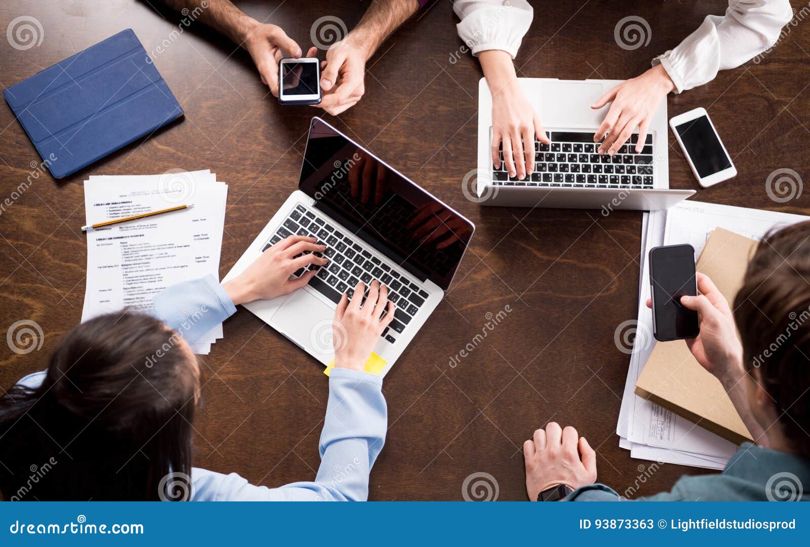 Young Businesspeople Sitting Together at Workplace and Using Digital ...