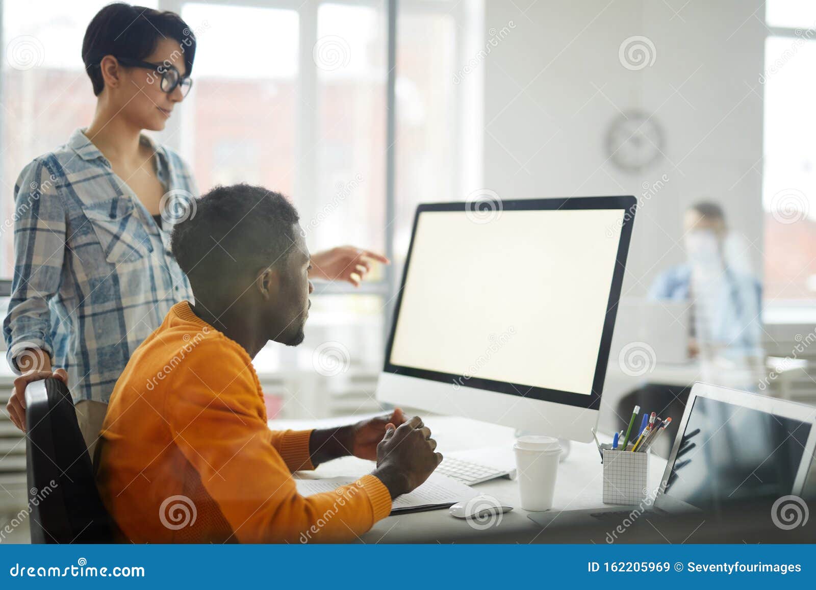 Young Businesspeople Using Computer in Office Stock Image - Image of ...