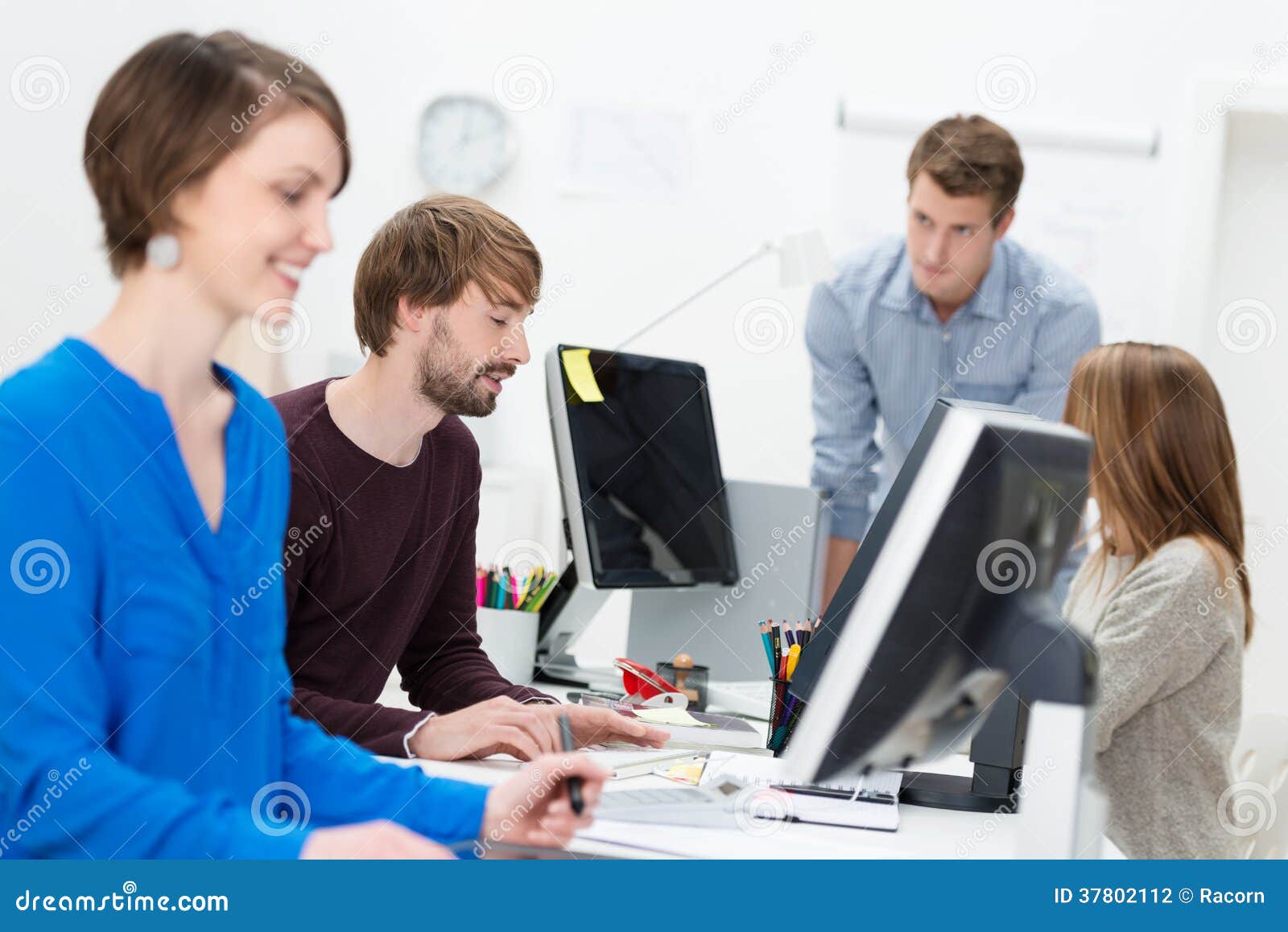 Young Businesspeople Working in a Busy Office Stock Photo - Image of ...