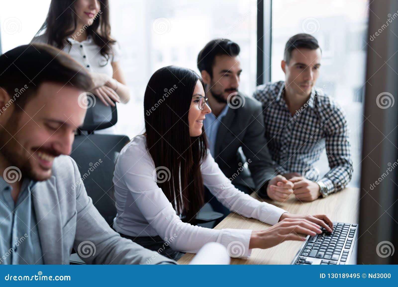 Young Businesspeople Working on Computer in Office Stock Image - Image ...