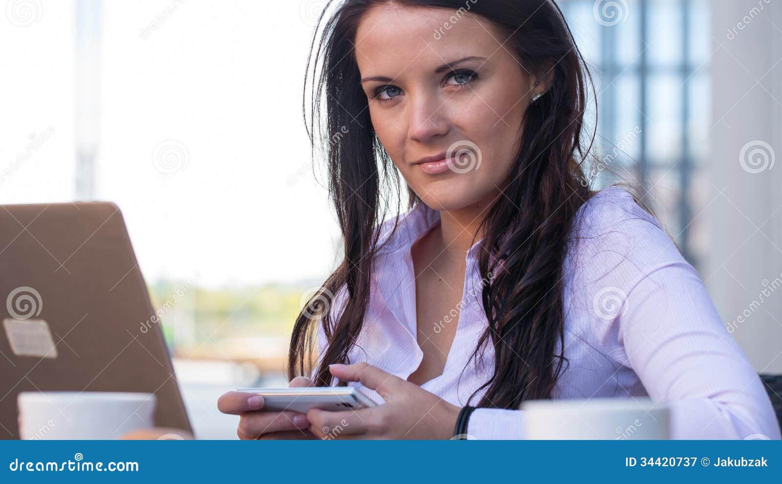 Young Businesswoman on a Coffee Break Using Mobile Phone. Stock Image ...