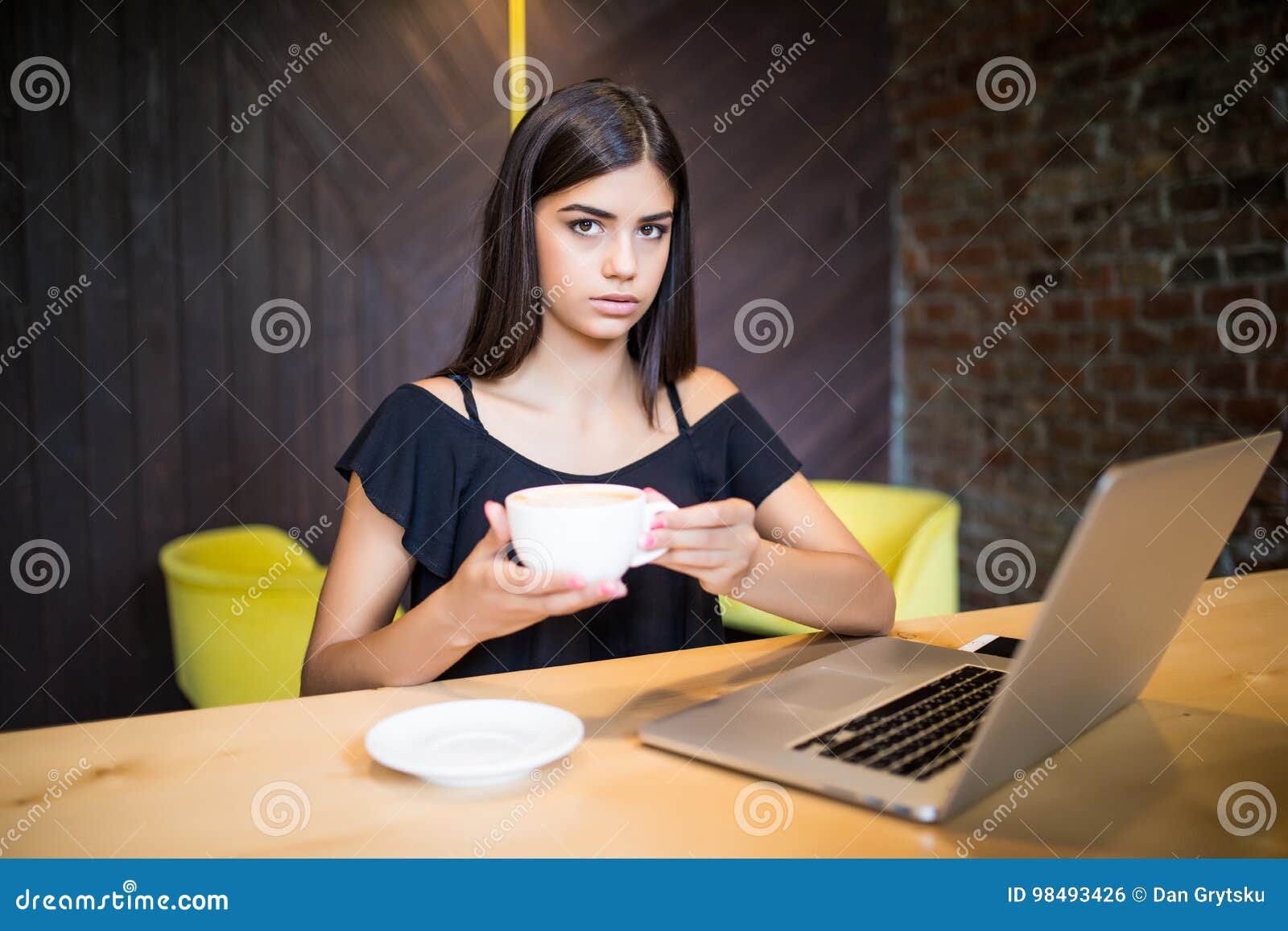 Young Woman Drinking Coffee and Using Computer in Cafe Stock Photo ...