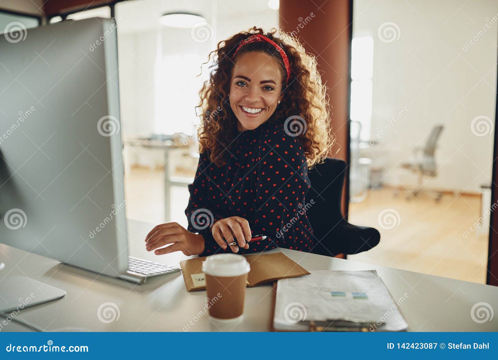 Smiling Young Businesswoman Working Online at Her Workstation Stock ... Smiling Young Businesswoman Working Online at Her Workstation Stock ...