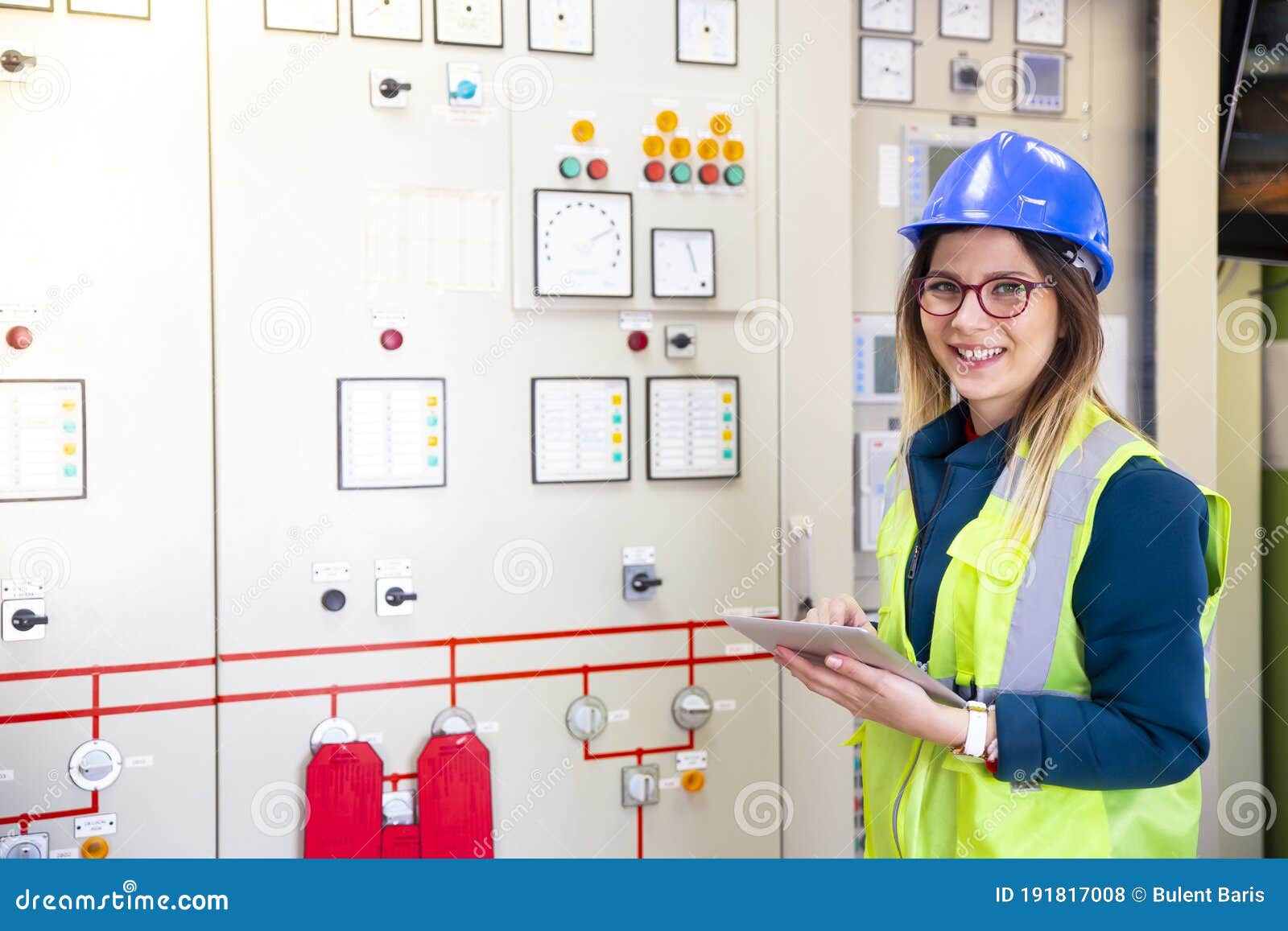 Young Businesswoman Standing In Front Of The Control Panel In The ...