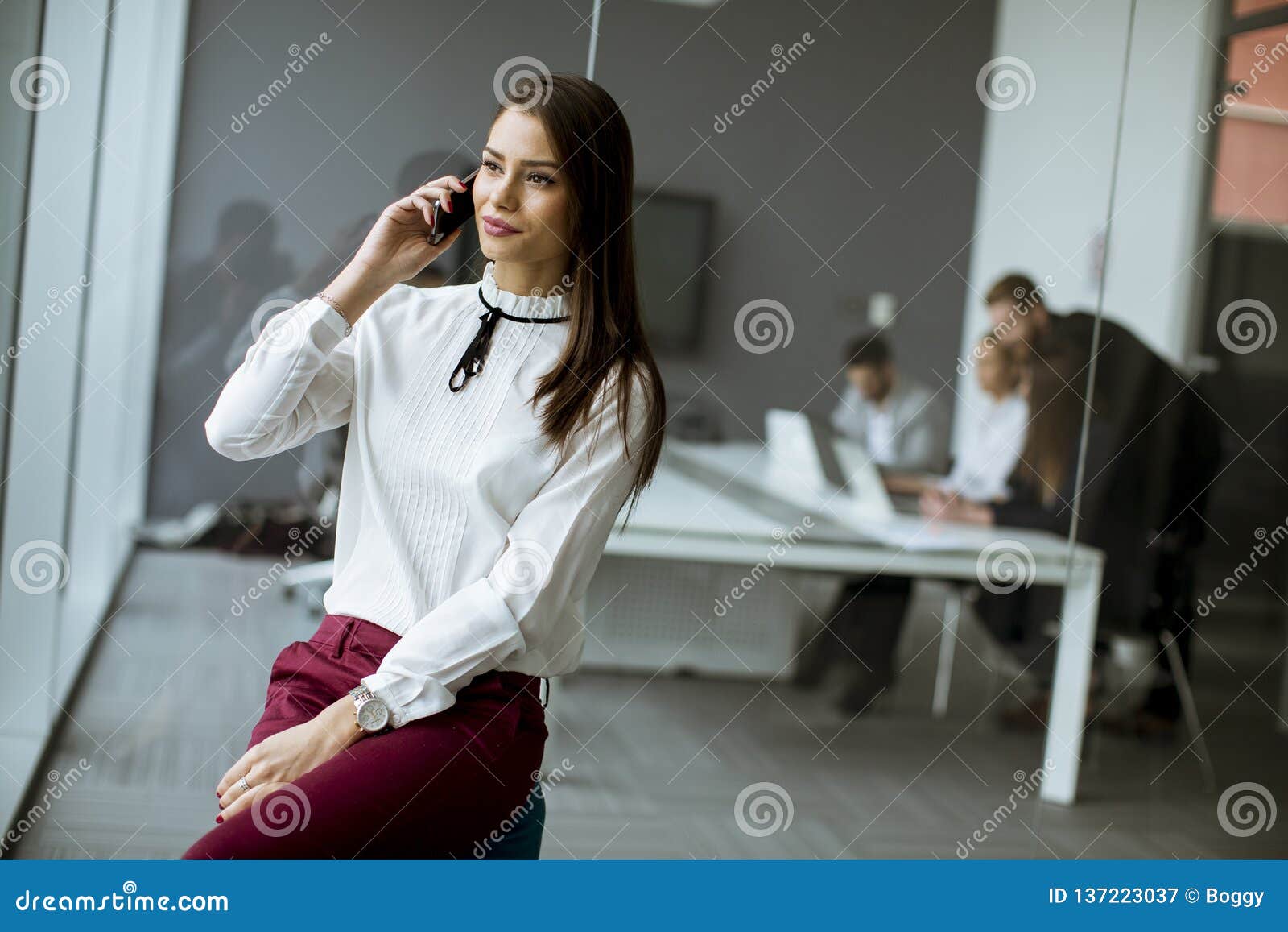 Young Businesswoman Using Mobile Phone in Modern Office Stock Image ... Young Businesswoman Using Mobile Phone in Modern Office Stock Image ...