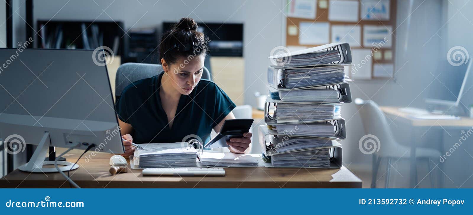 Young Businesswoman Working at Office with Stack of Folders Stock Photo ...