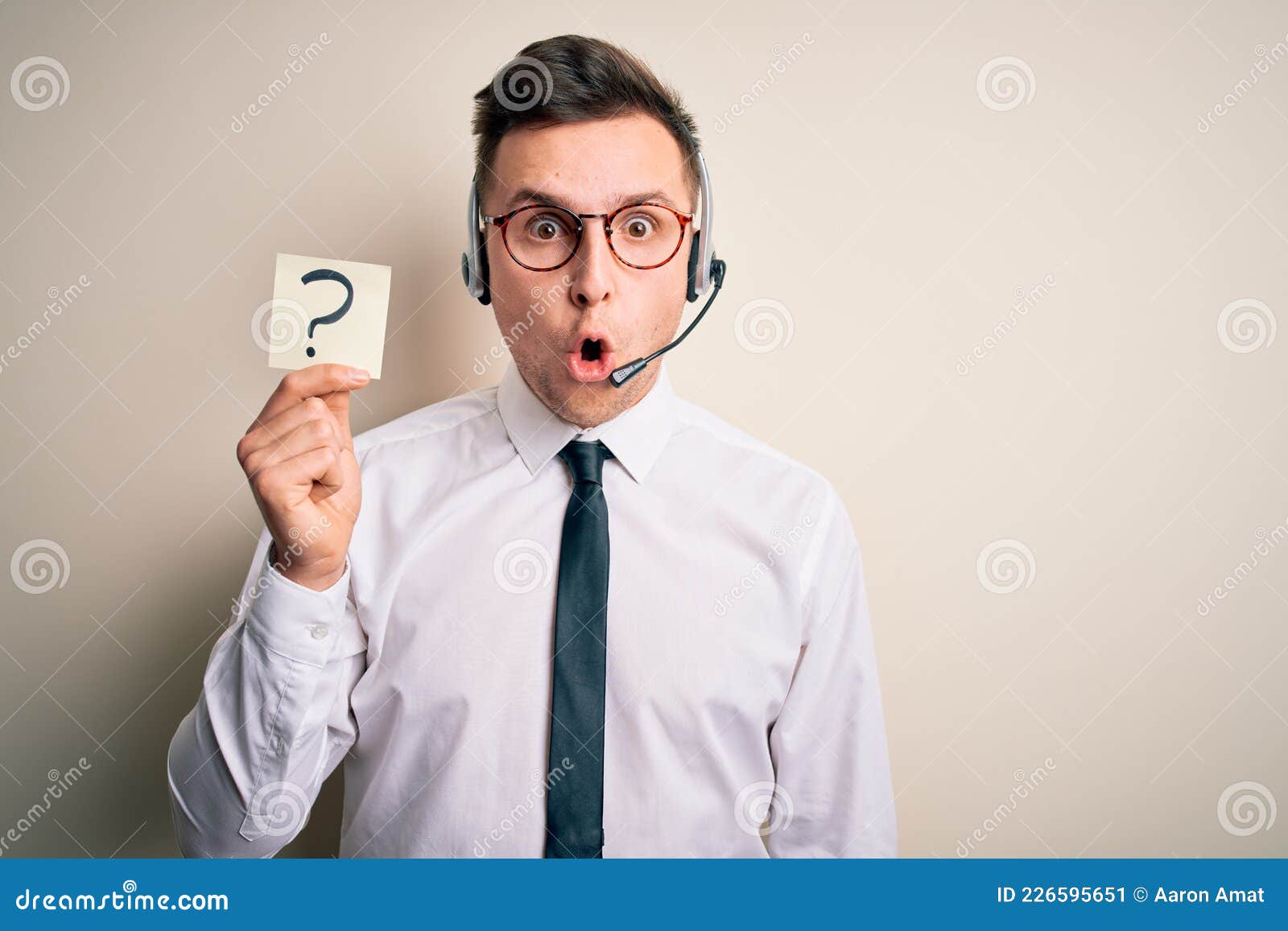 Young Call Center Operator Man Wearing Headset Holding Paper Note with ...
