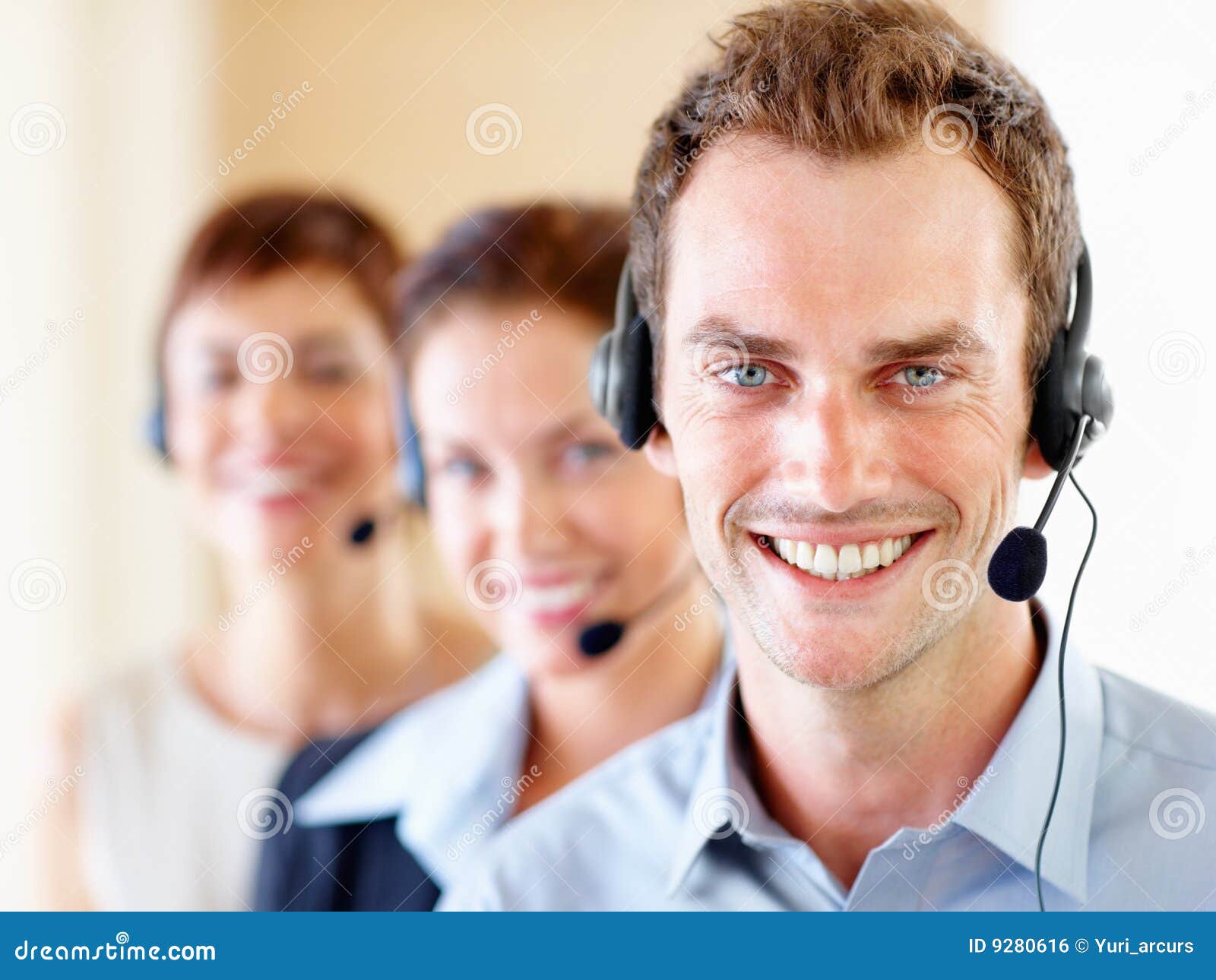 Young Call Centre Guy with Colleagues at the Back Stock Photo - Image ...