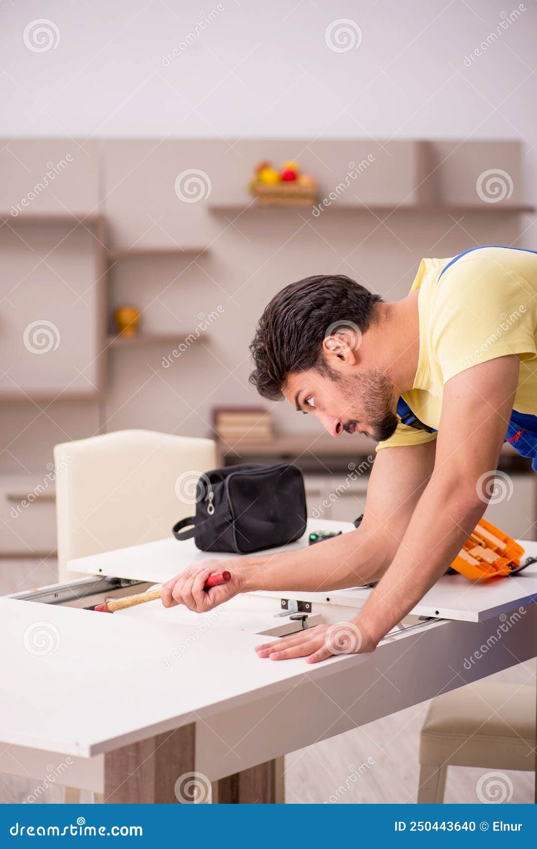 Young Male Carpenter Repairing Table at Home Stock Photo - Image of ...