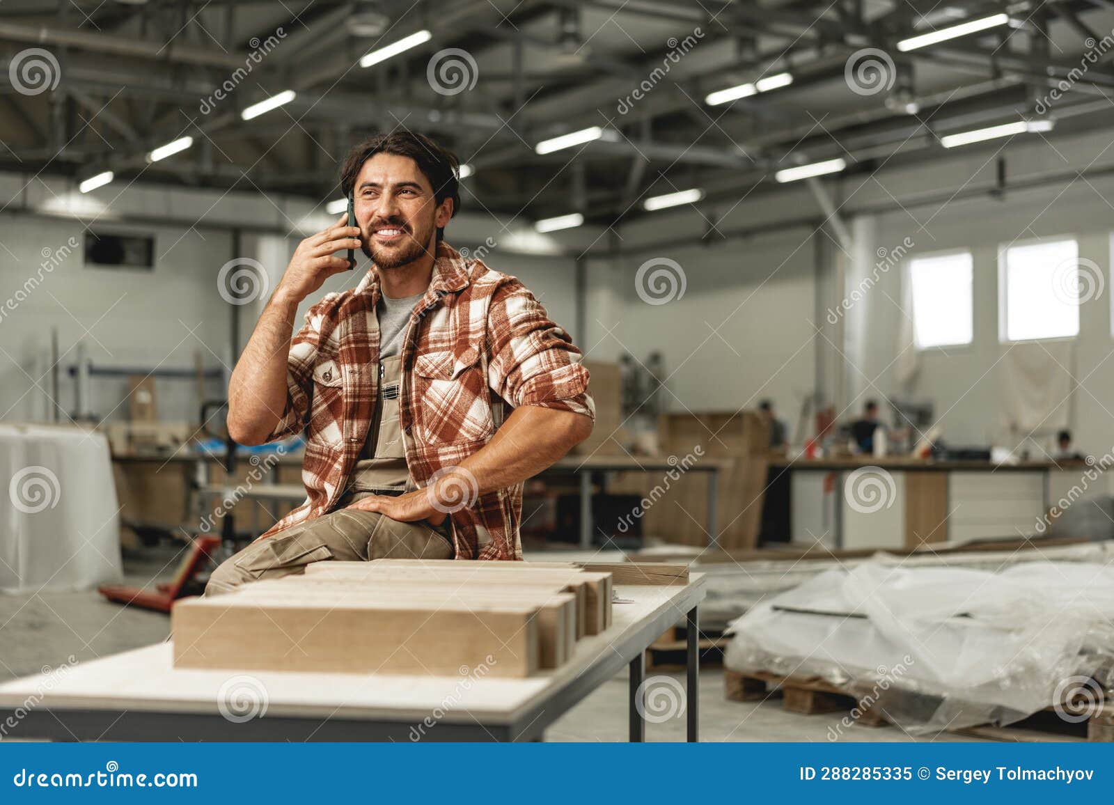 Young Carpenter Using His Mobile Phone in Workshop Close Up Stock Image ...