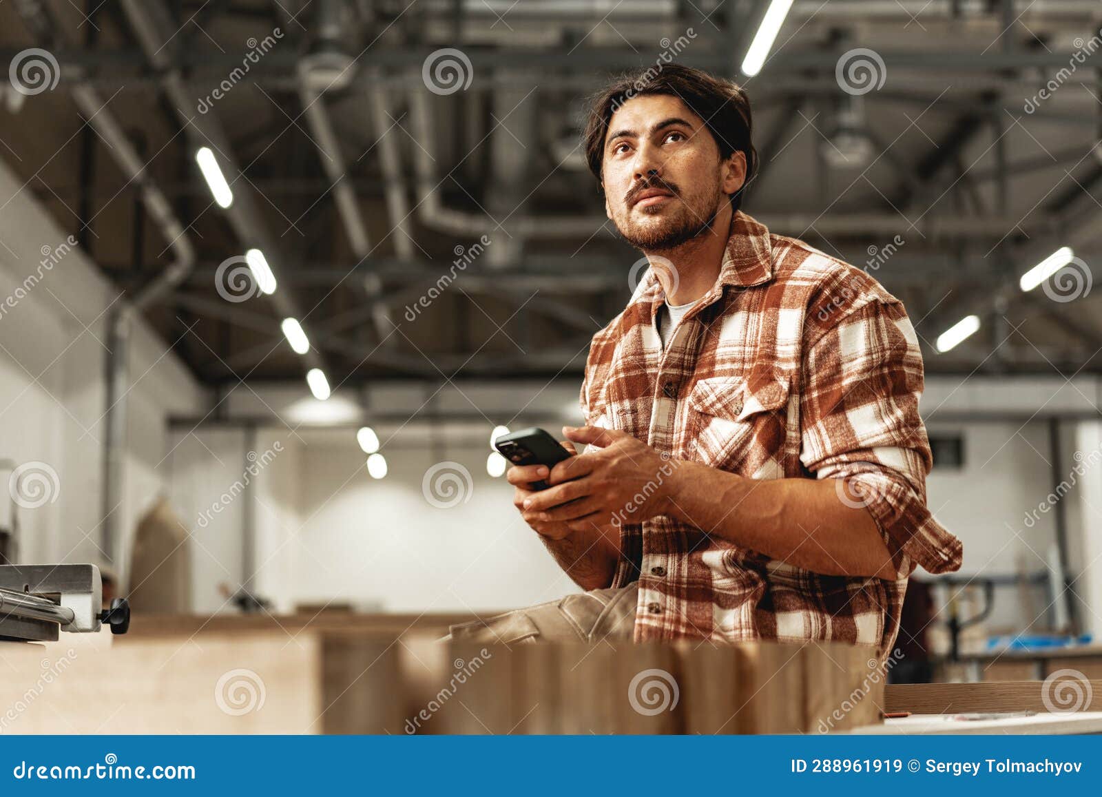 Young Carpenter Using His Mobile Phone in Workshop Close Up Stock Image ...
