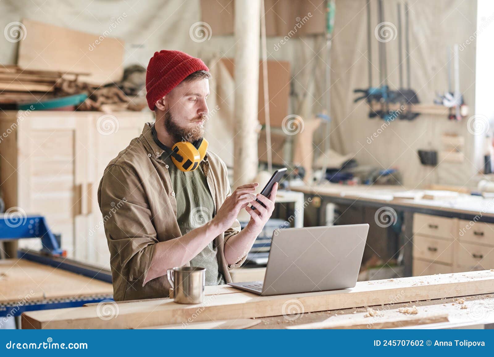 Young Carpenter Using Smartphone in Workshop Stock Photo - Image of ...