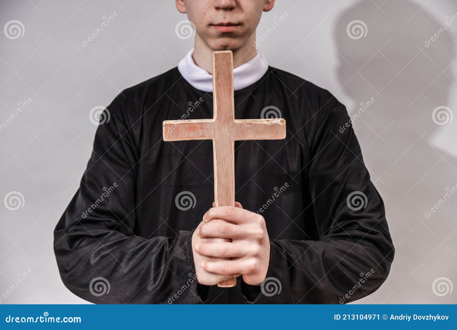 A Young Catholic Priest Holds a Cross in Front of Him. the Concept of ...