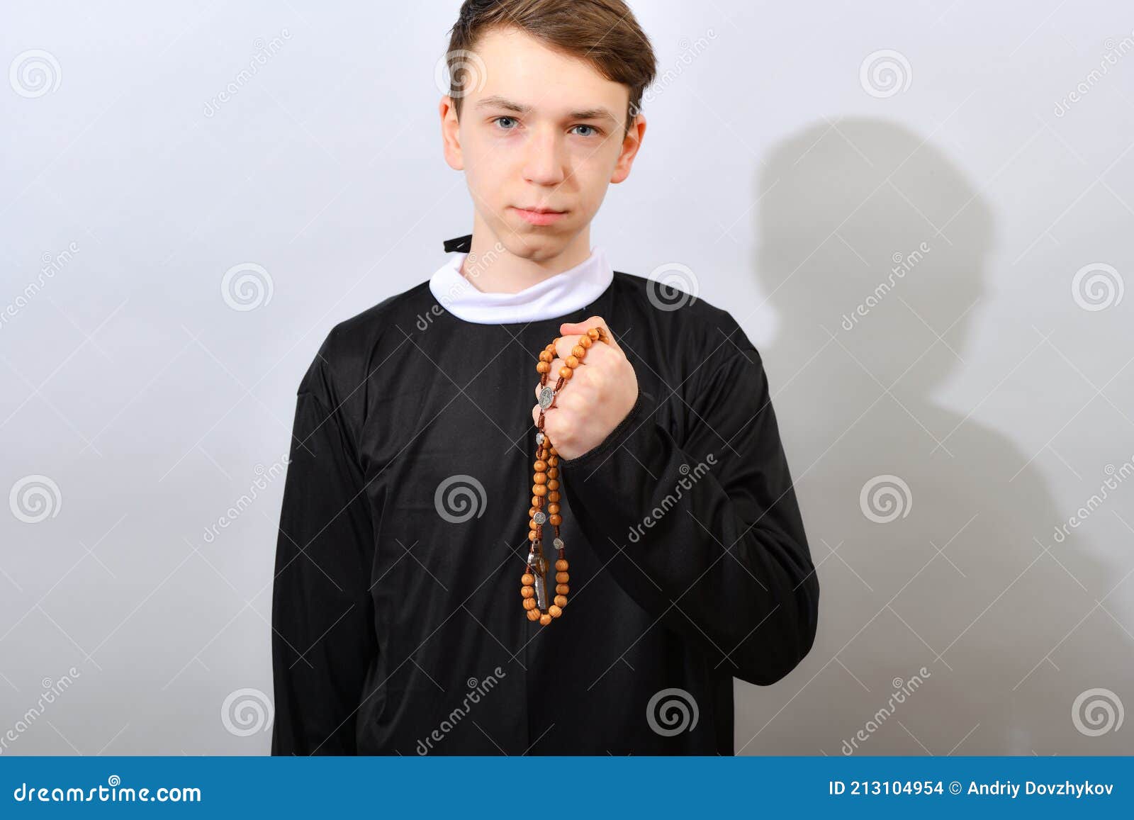 Young Catholic Praying Priest. Portrait Of Priest Next To The Candles ...