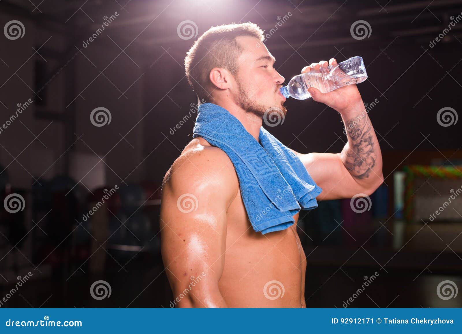 Young Caucasian Bodybuilder in the Gym Drinking a Bottle Water. Stock ...
