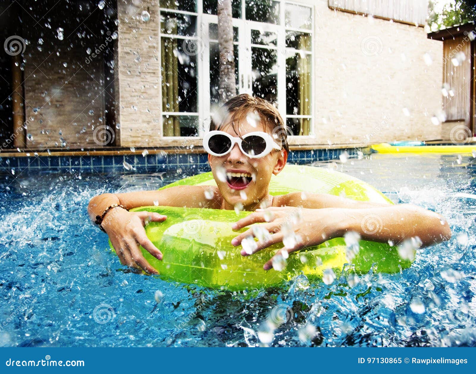 Young Caucasian Boy Enjoying Floating in the Pool with Tube Stock Image ...