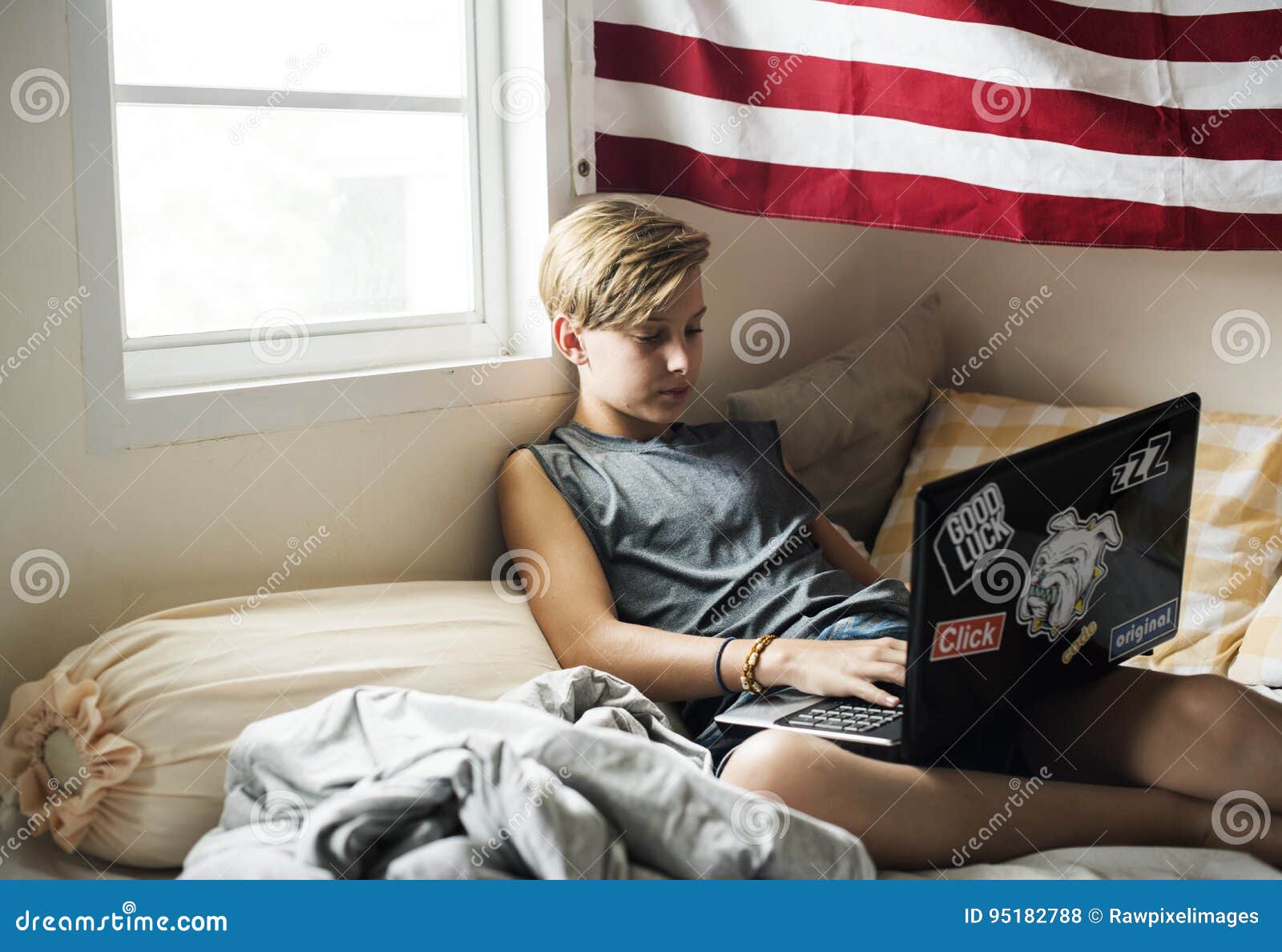 Young Caucasian Boy Lying Using Computer Laptop on Bed Stock Photo ...