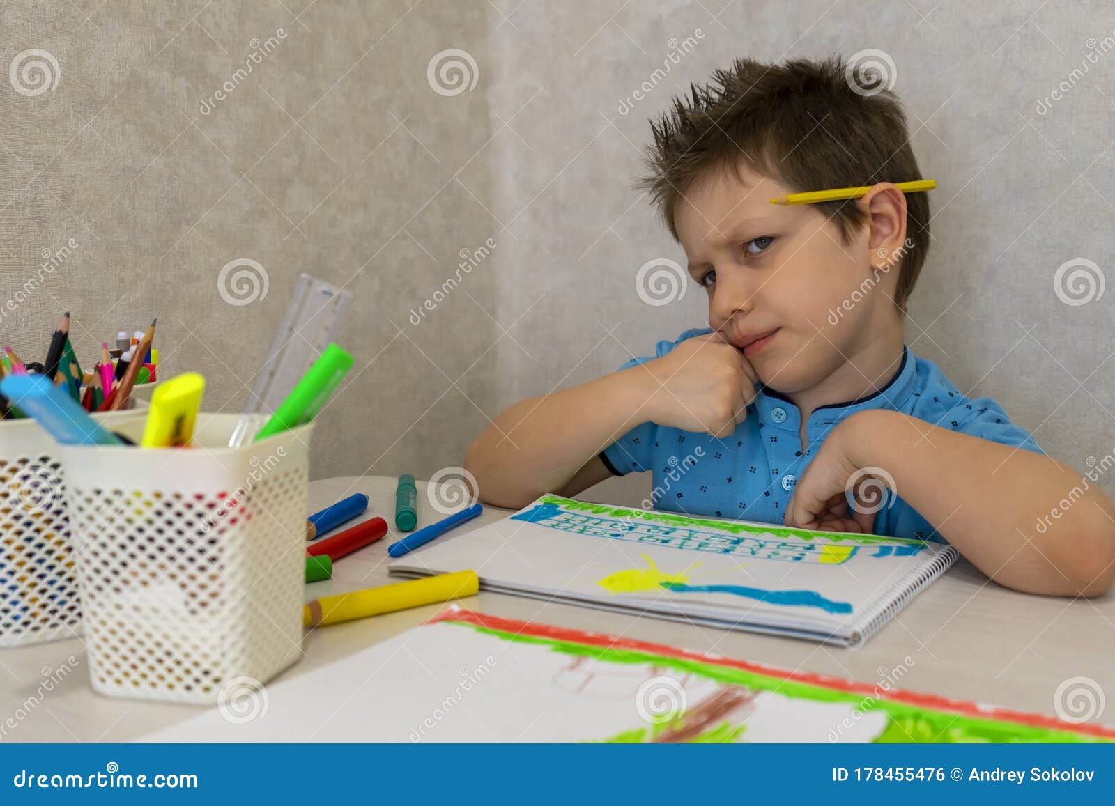 A Young Caucasian Boy Thinks that he Can Draw with Pencils on White ...