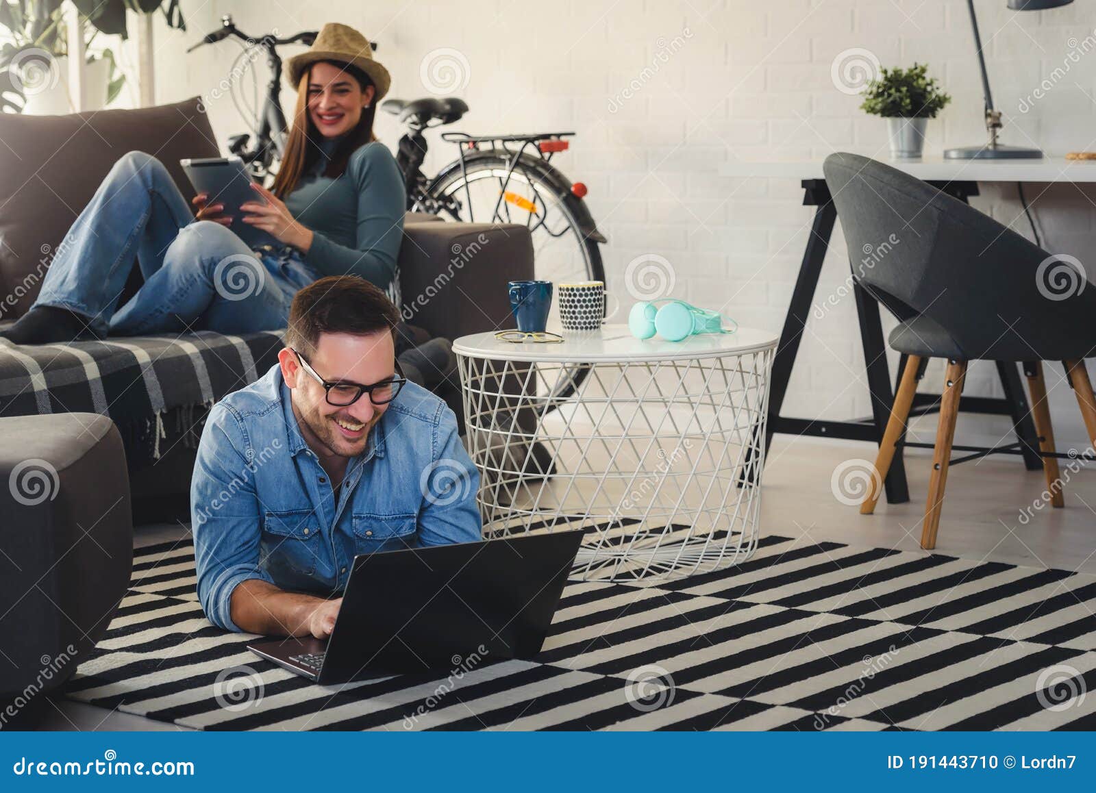 Young Caucasian Couple Using Mobile Devices for Work from Home Stock ...