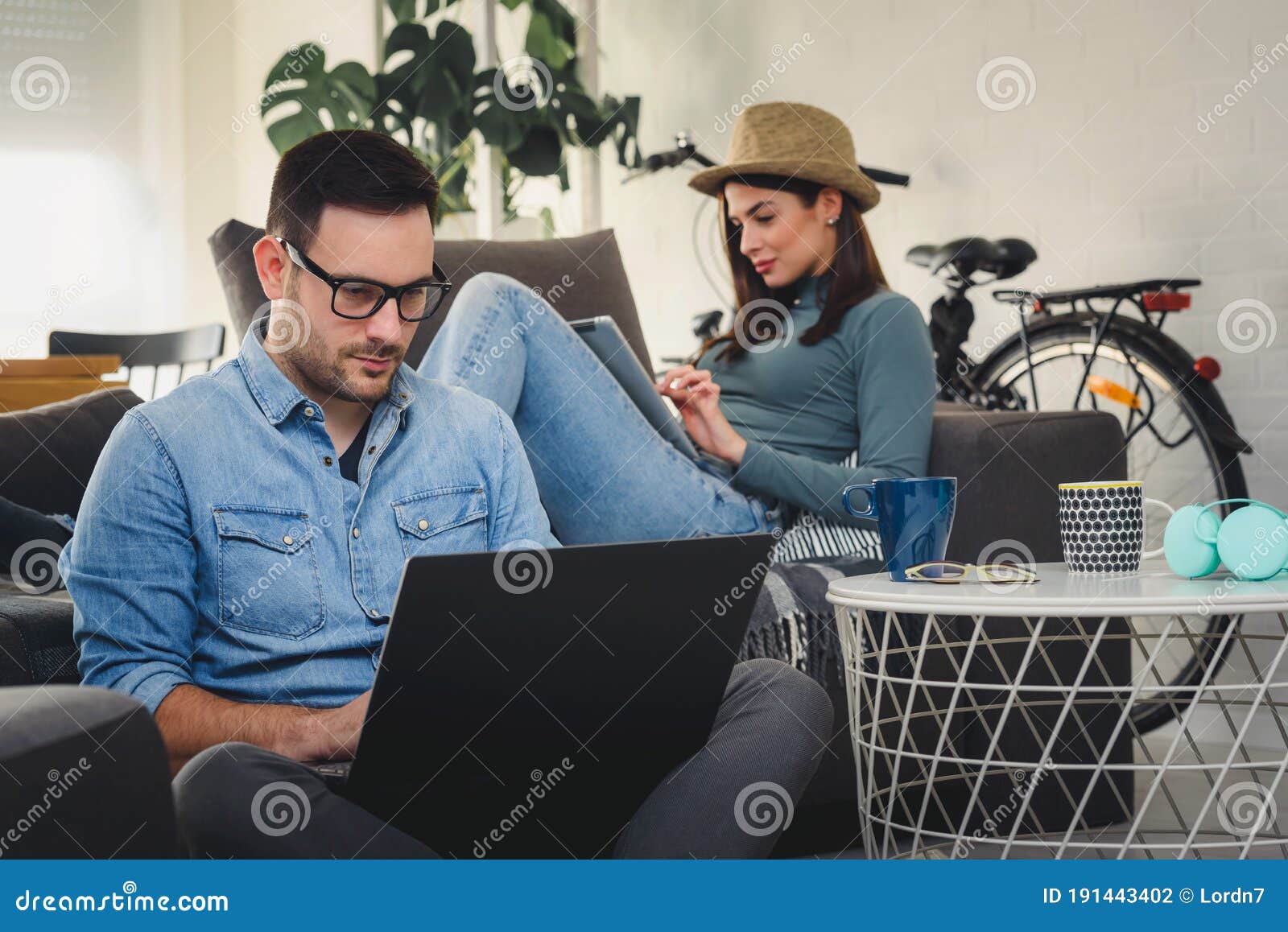 Young Caucasian Couple Using Mobile Devices for Work from Home Stock ...