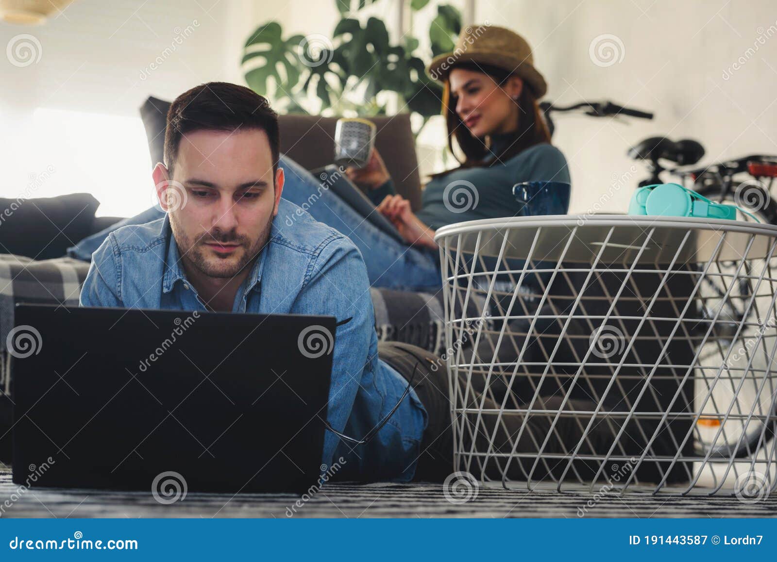 Young Caucasian Couple Using Mobile Devices for Work from Home Stock ...