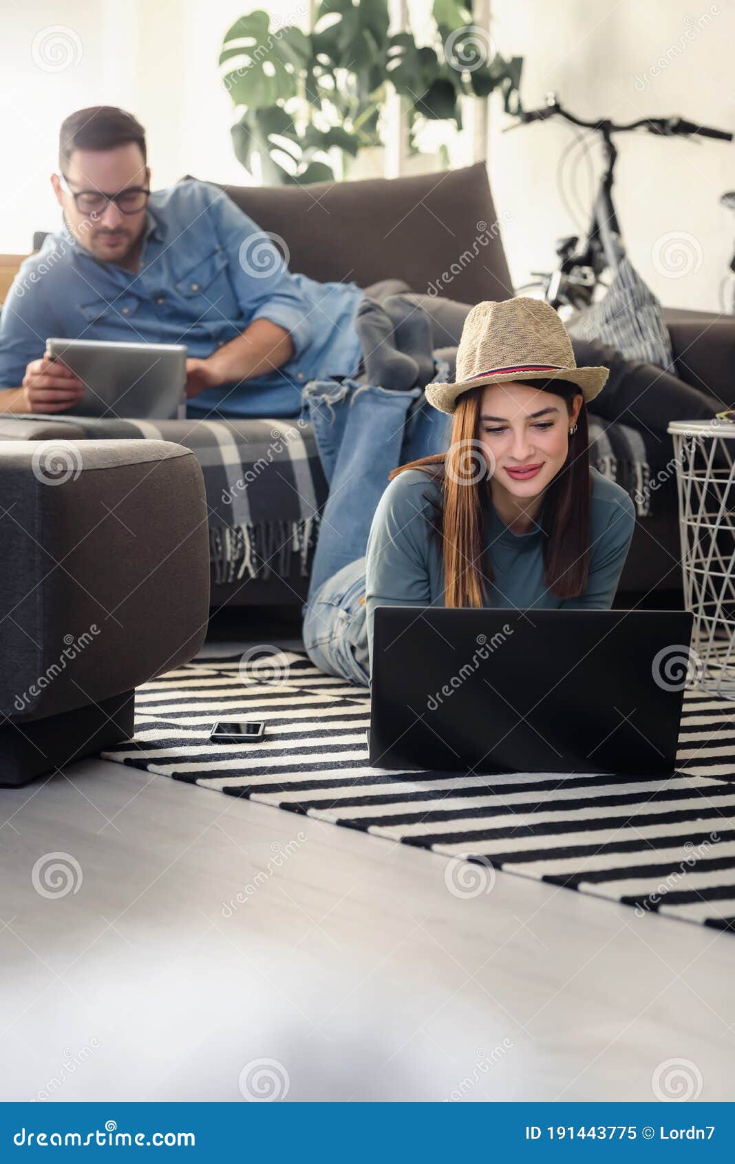Young Caucasian Couple Using Mobile Devices for Work from Home Stock ...