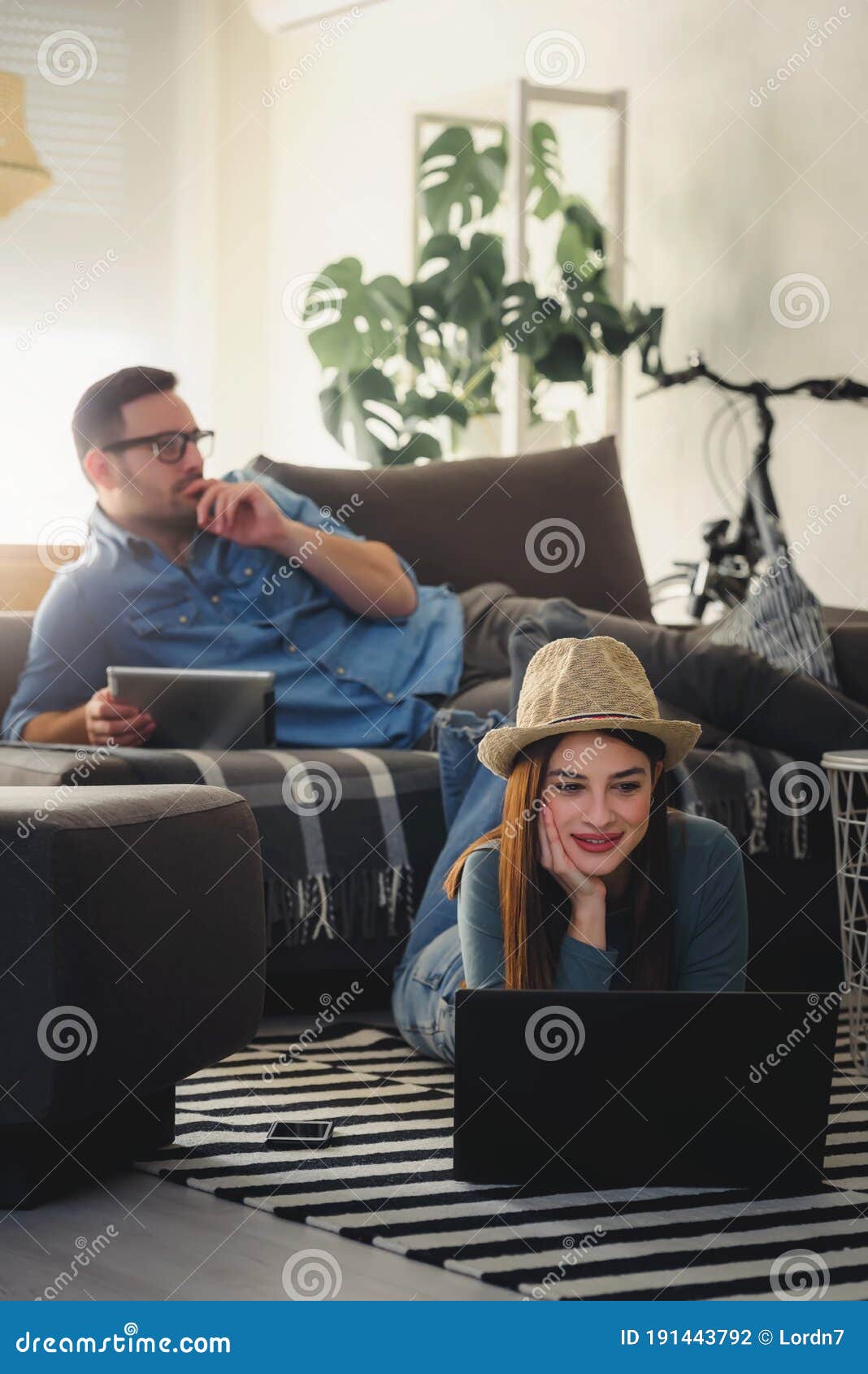Young Caucasian Couple Using Mobile Devices for Work from Home Stock ...